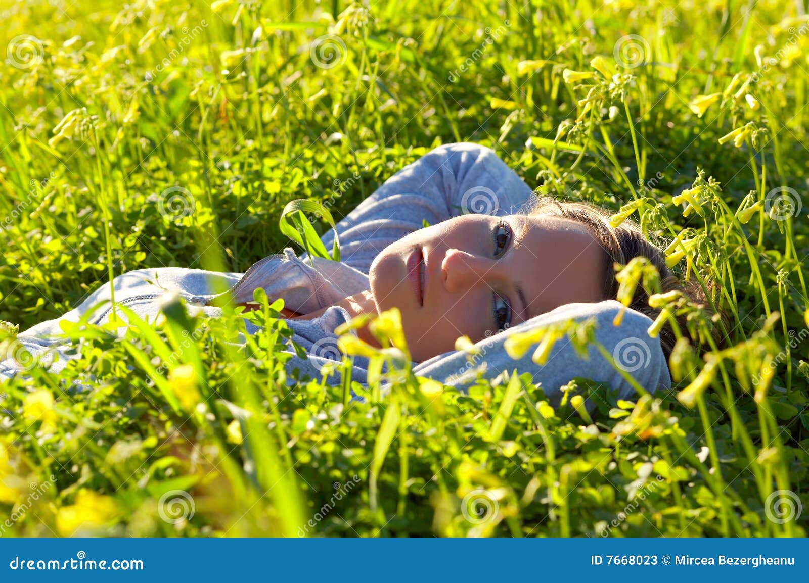 Young Woman Laying on Field Stock Image - Image of girl, bloom: 7668023
