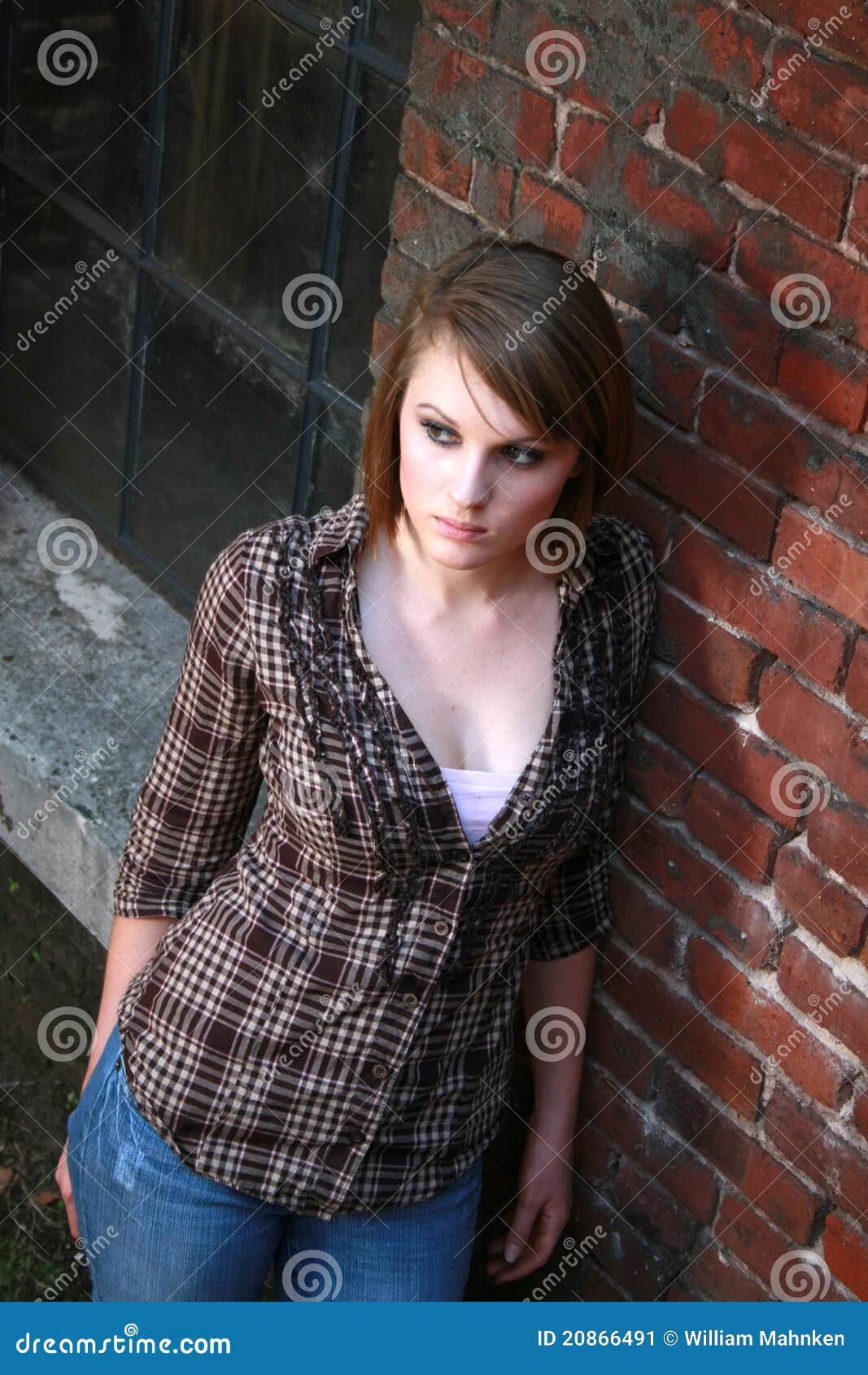 Young Woman Leaning Against Brick Wall Stock Image - Image of eyes ...