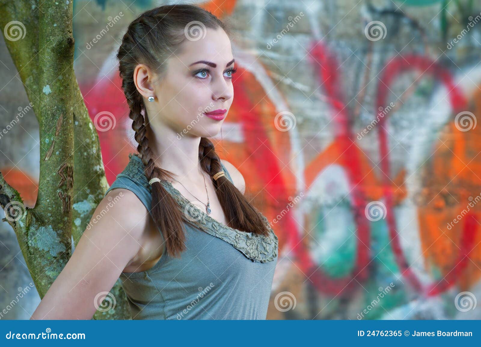 Young Woman Leaning on a Young Tree Stock Image - Image of streets ...