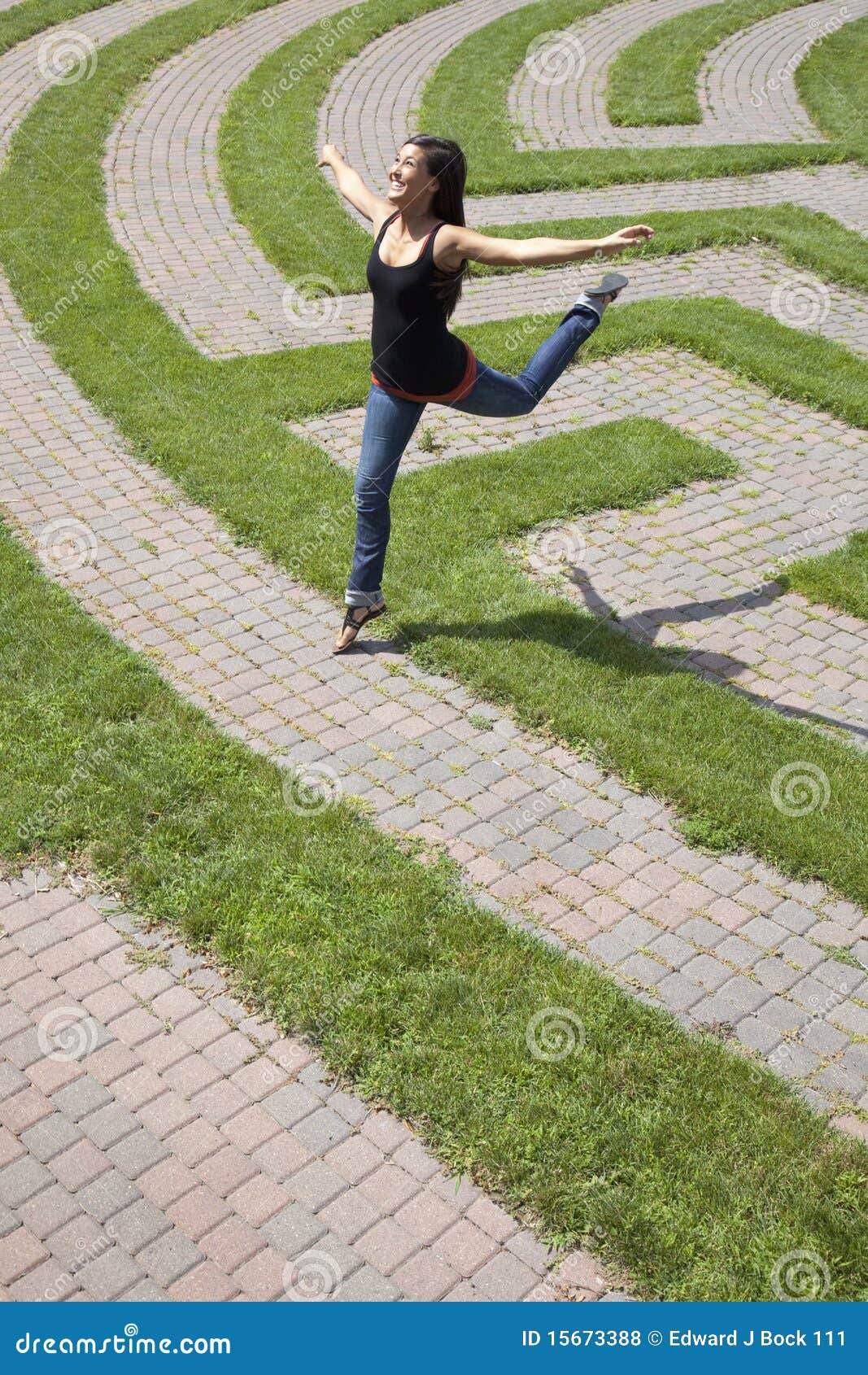Young Woman Leaping Over a Grass Maze Stock Photo - Image of complexity ...