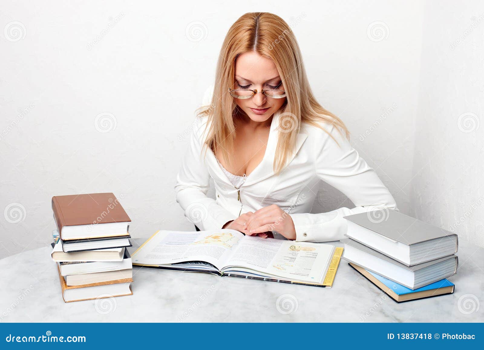 Young Woman Learning at Table with a Lot of Books Stock Photo - Image ...