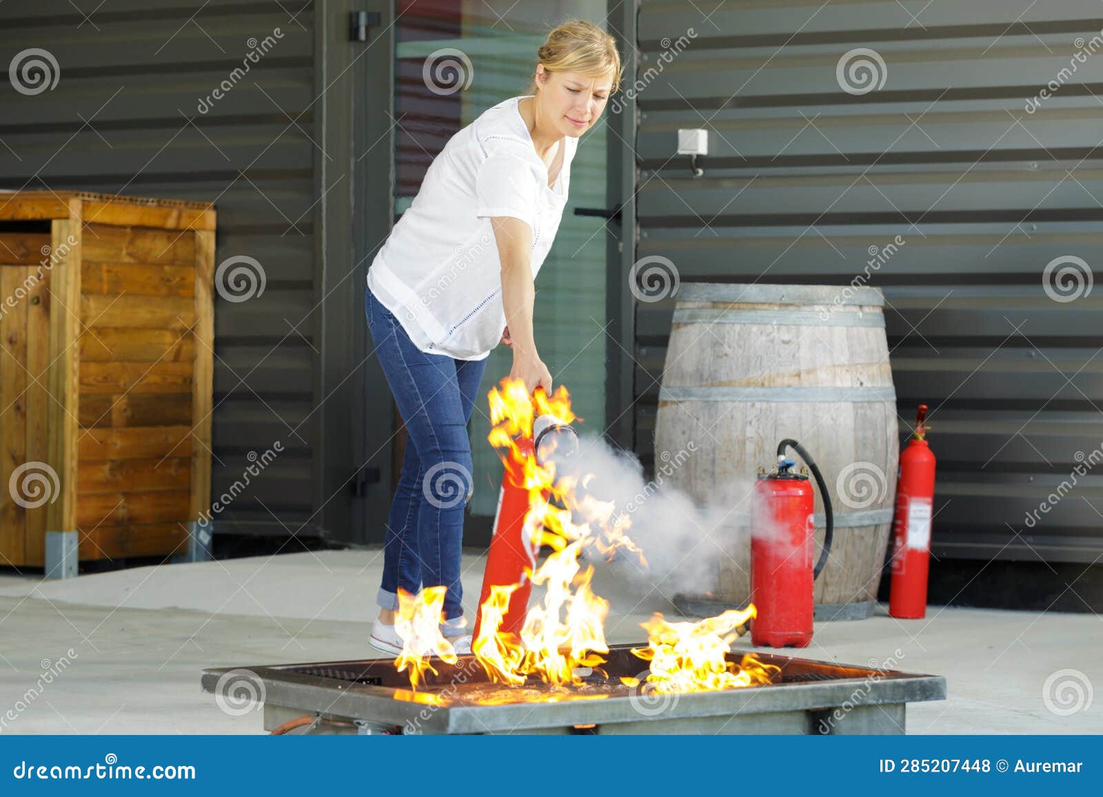 Young Woman Learning To Use Fire Extinguisher Stock Photo - Image of ...