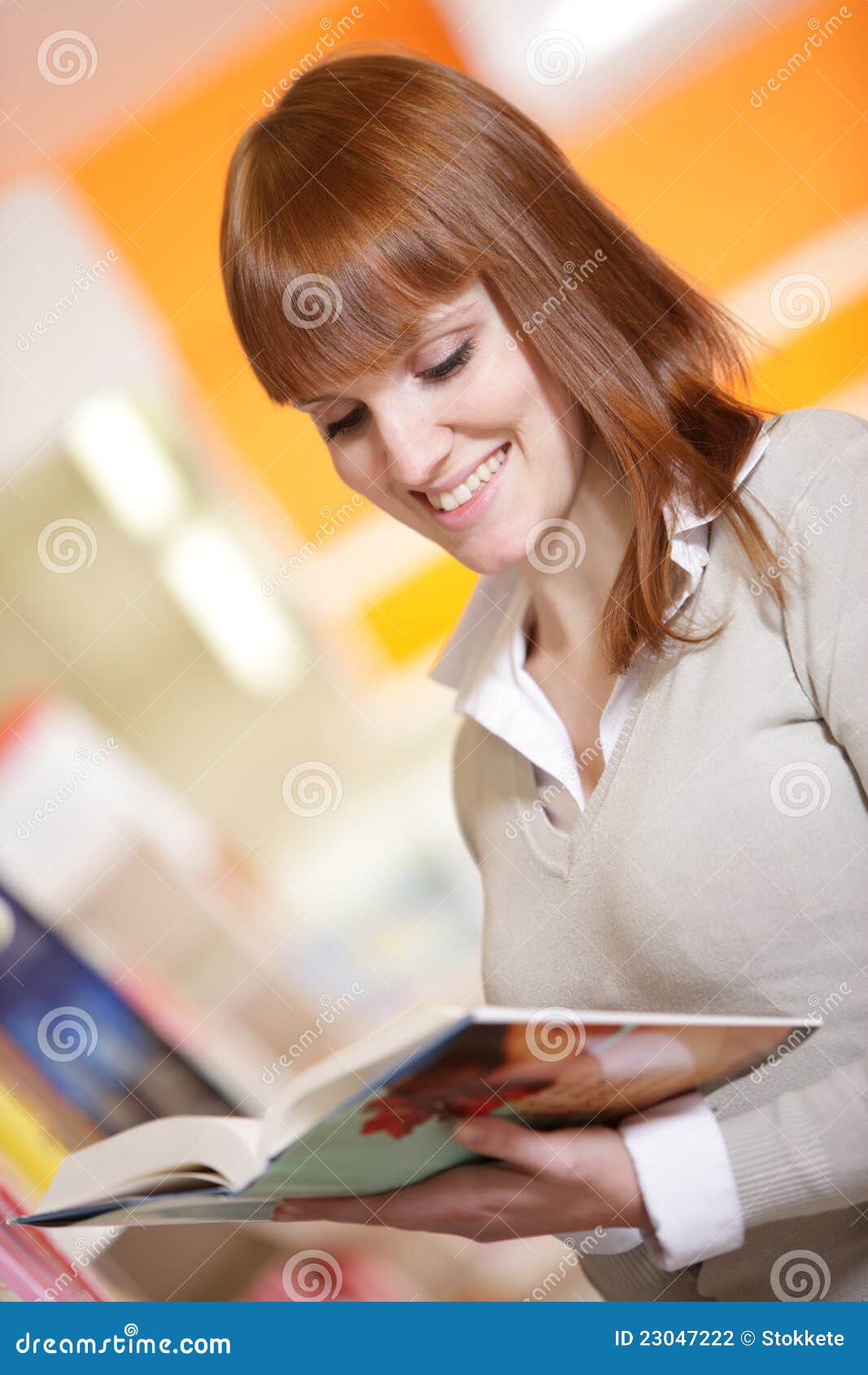 Young woman in a library stock photo. Image of bookshelf - 23047222