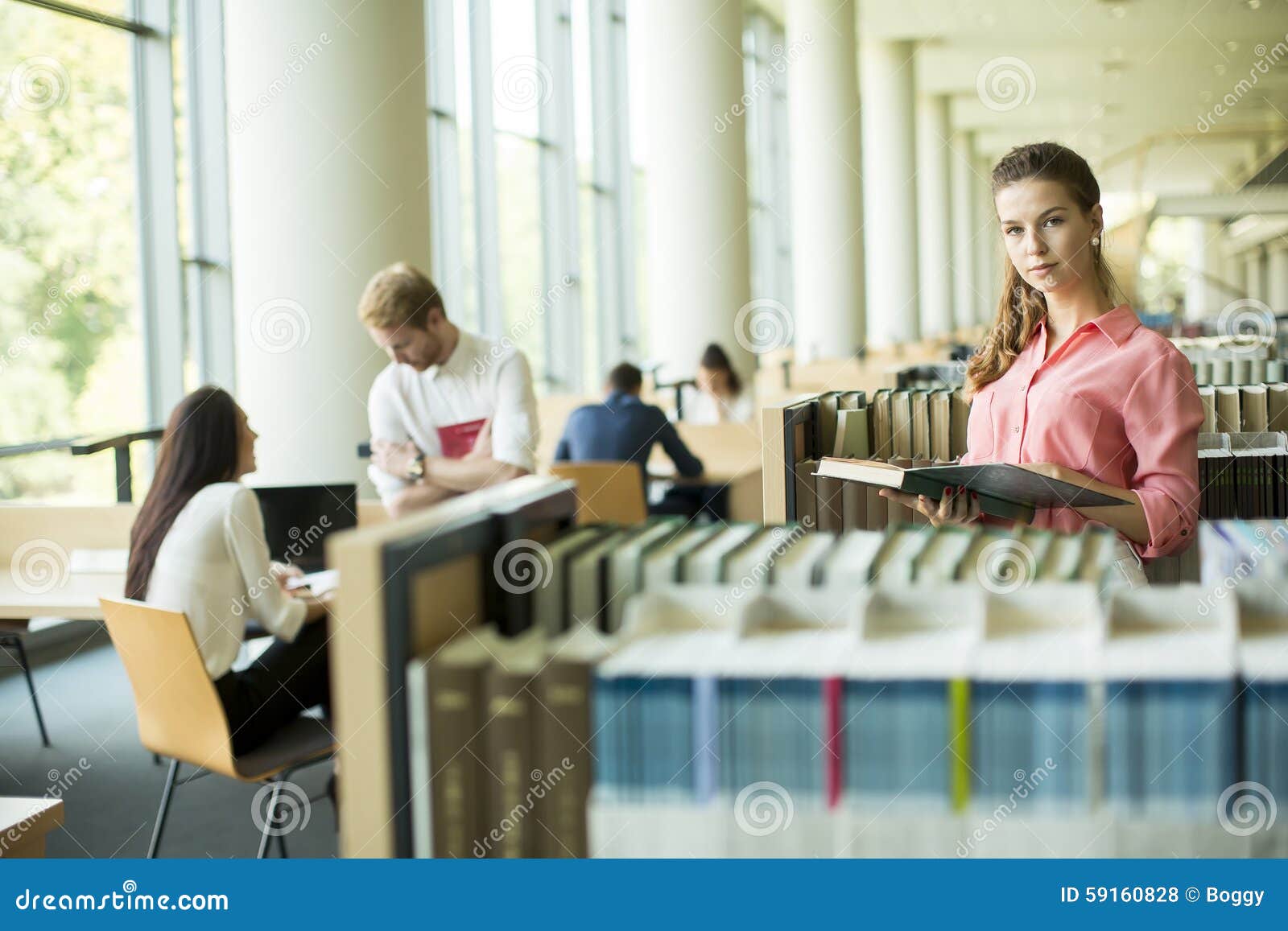 Young woman in the library stock photo. Image of reader - 59160828