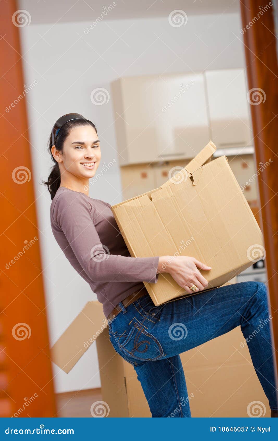 Young Woman Lifting Cardboard Box Stock Image - Image of brunette ...