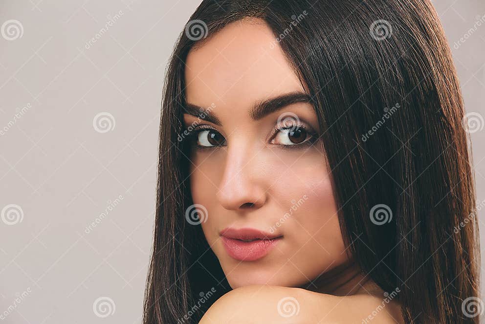 Young Woman With Long Black Hair Posing On Camera Close Up Portrait Of