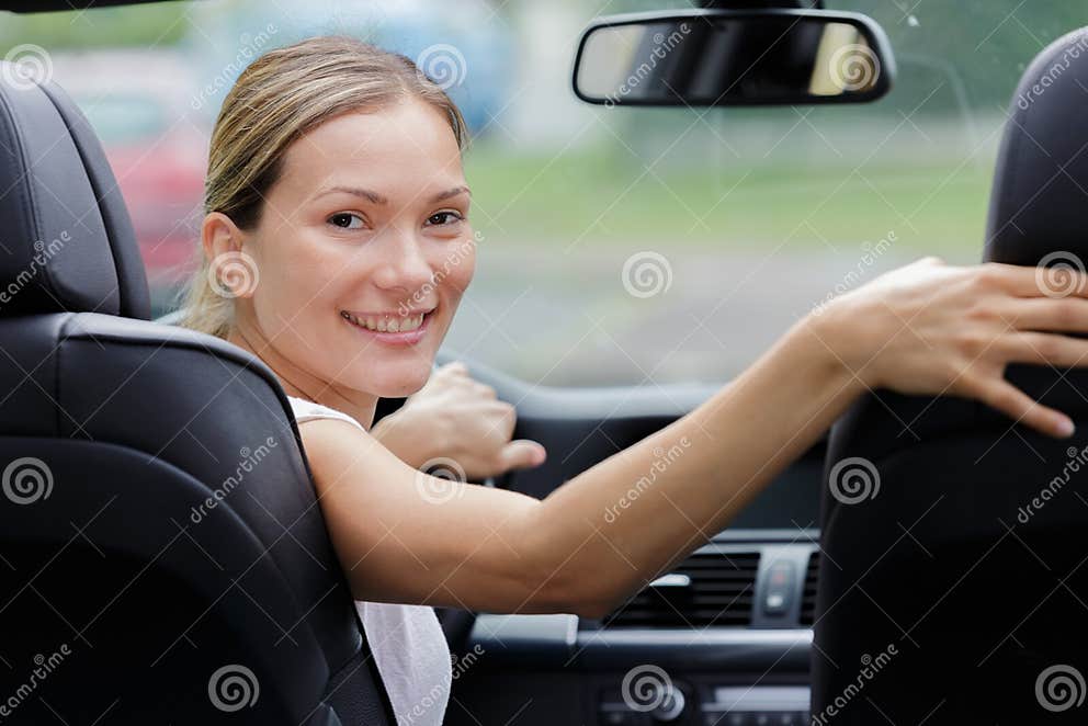 Young Woman Looking Back and Smiling Stock Image - Image of convertible ...