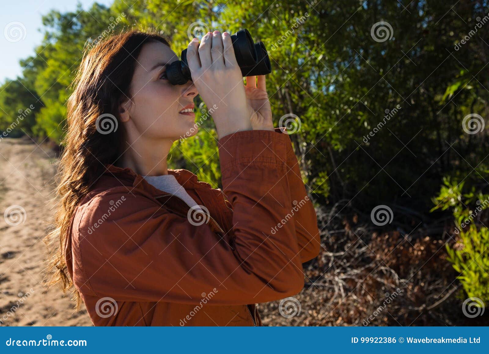Woman Looking through Binocular by Tree Stock Photo - Image of ...