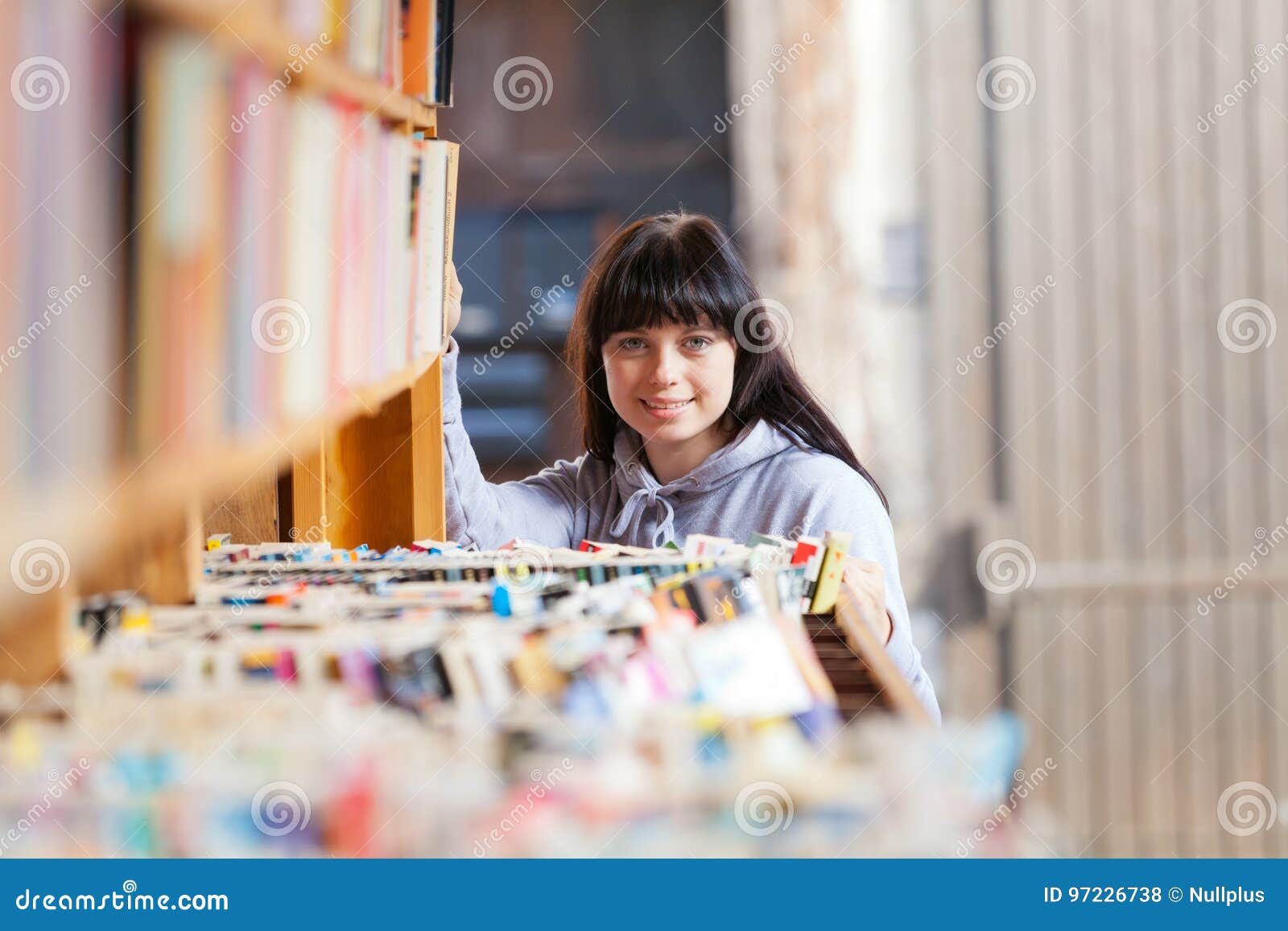 Young Woman Looking at Books in a Bookstore Stock Photo - Image of ...
