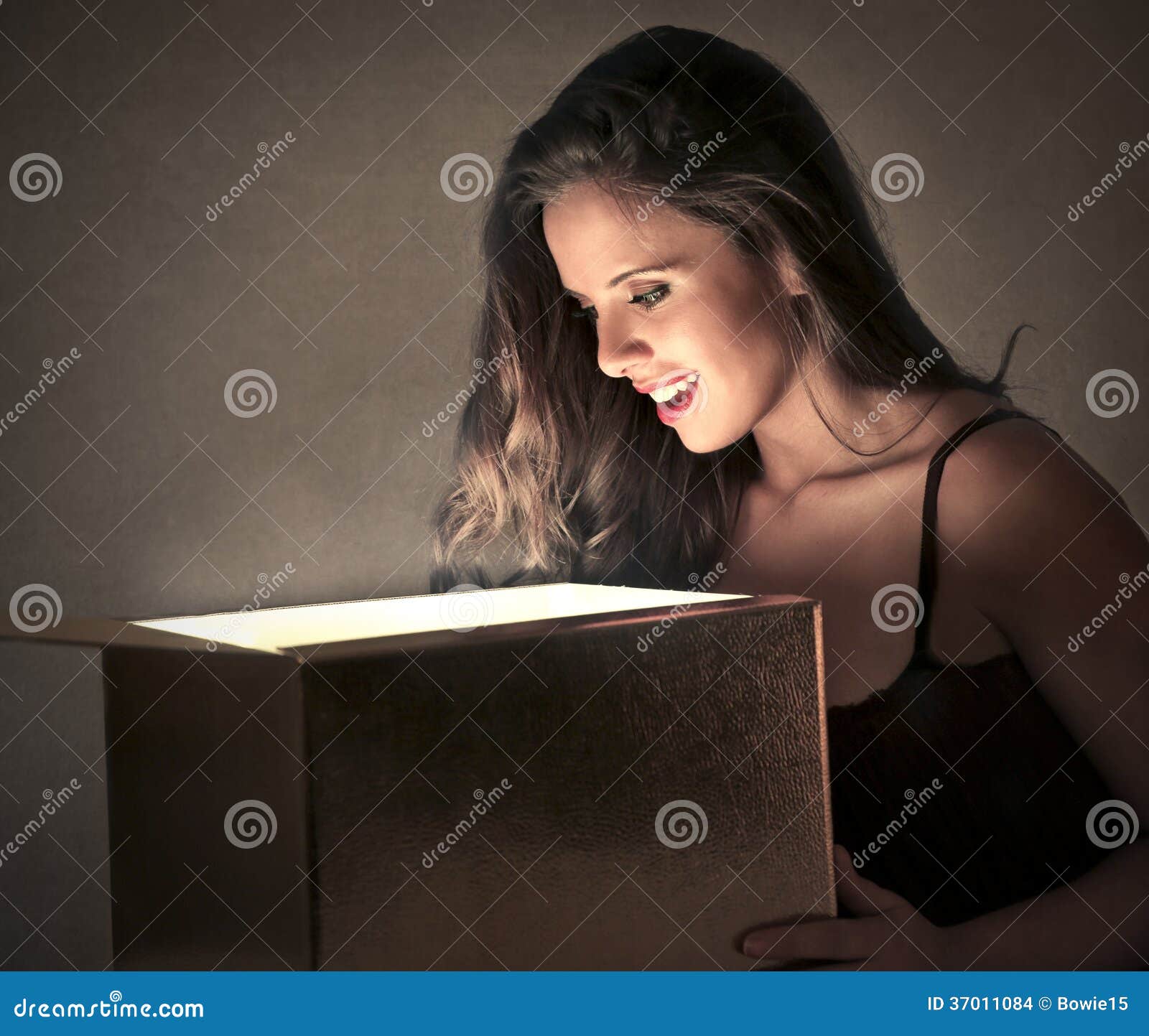 Young Woman Looking into a Box Stock Photo - Image of birthday, wonder ...