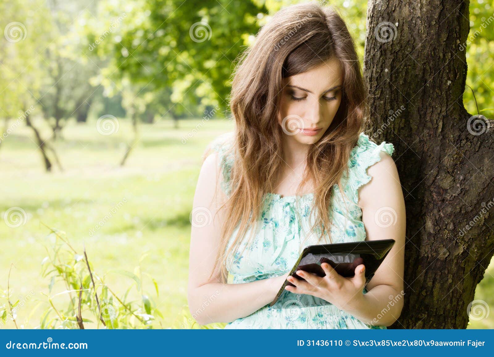 Young Woman Looking at Her Tablet Stock Photo - Image of portrait ...