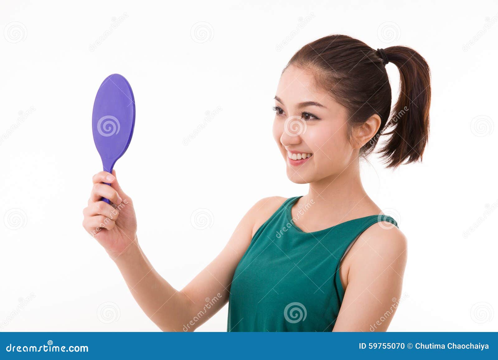 A Young Woman Looking at Herself in a Hand Mirror Stock Photo - Image ...