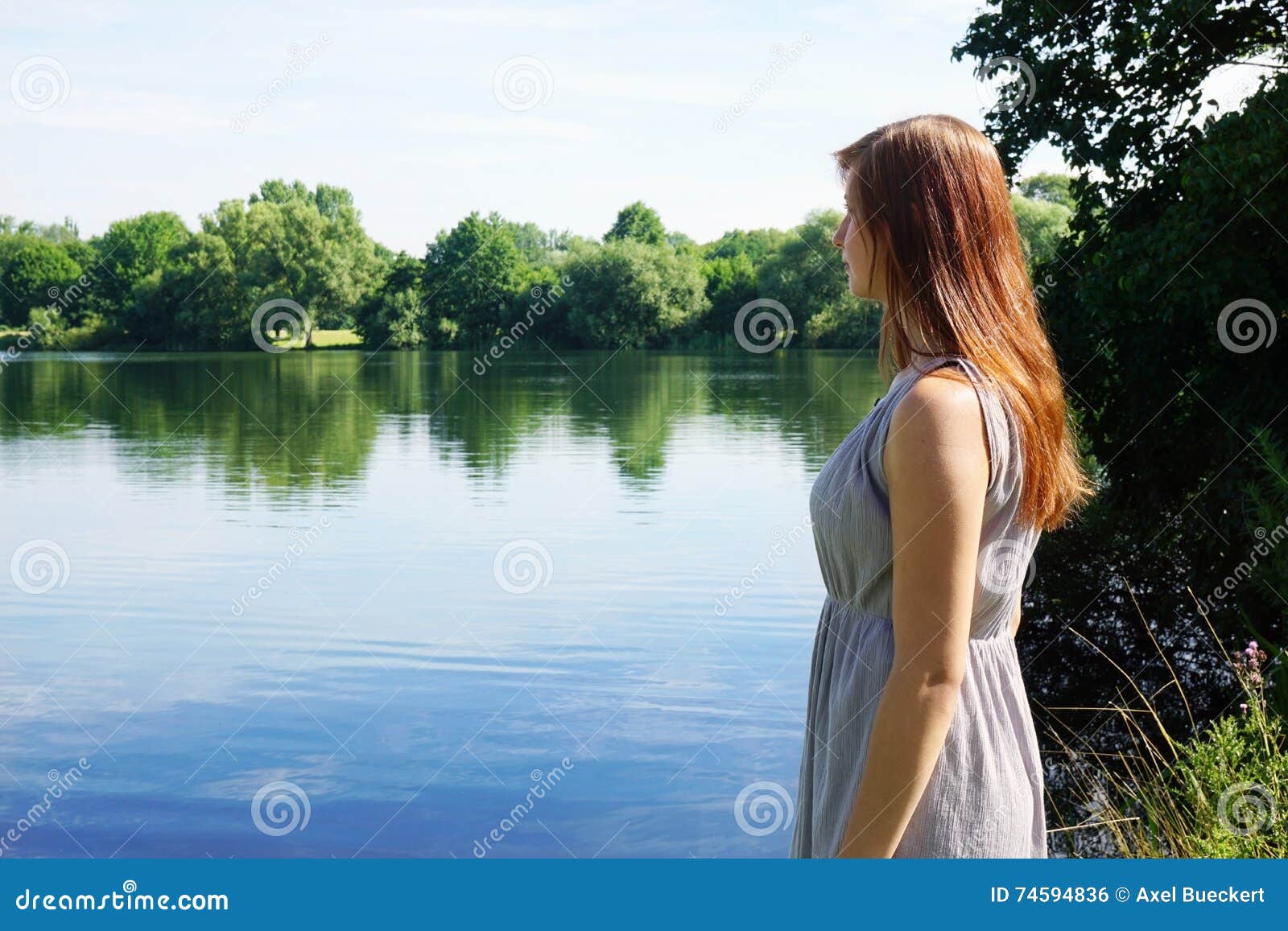 Young Woman Looking at Idyllic Lake Stock Photo - Image of blue, lady ...