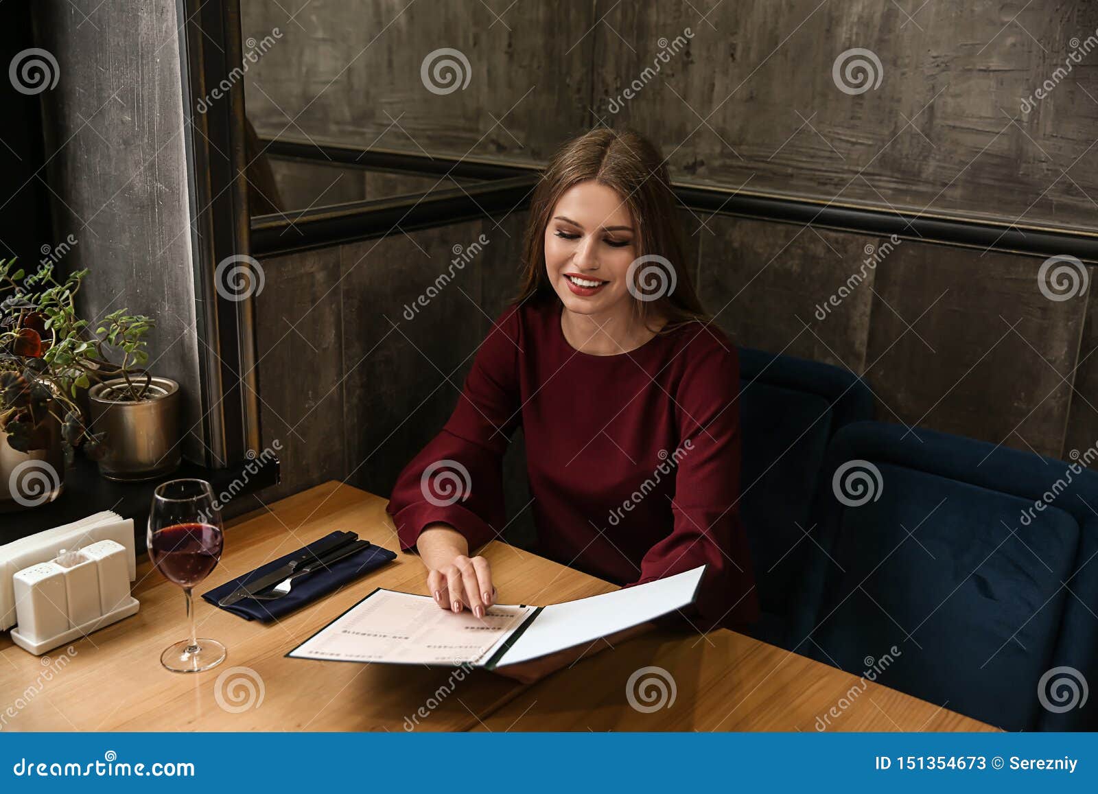 Young Woman Looking through Menu in Restaurant Stock Image - Image of ...