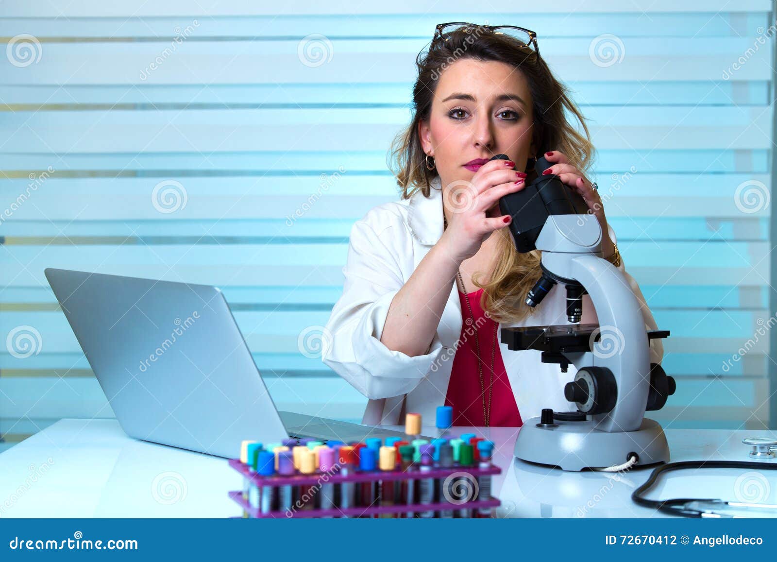 Young Woman Looking through a Microscope in the Lab Stock Photo - Image ...