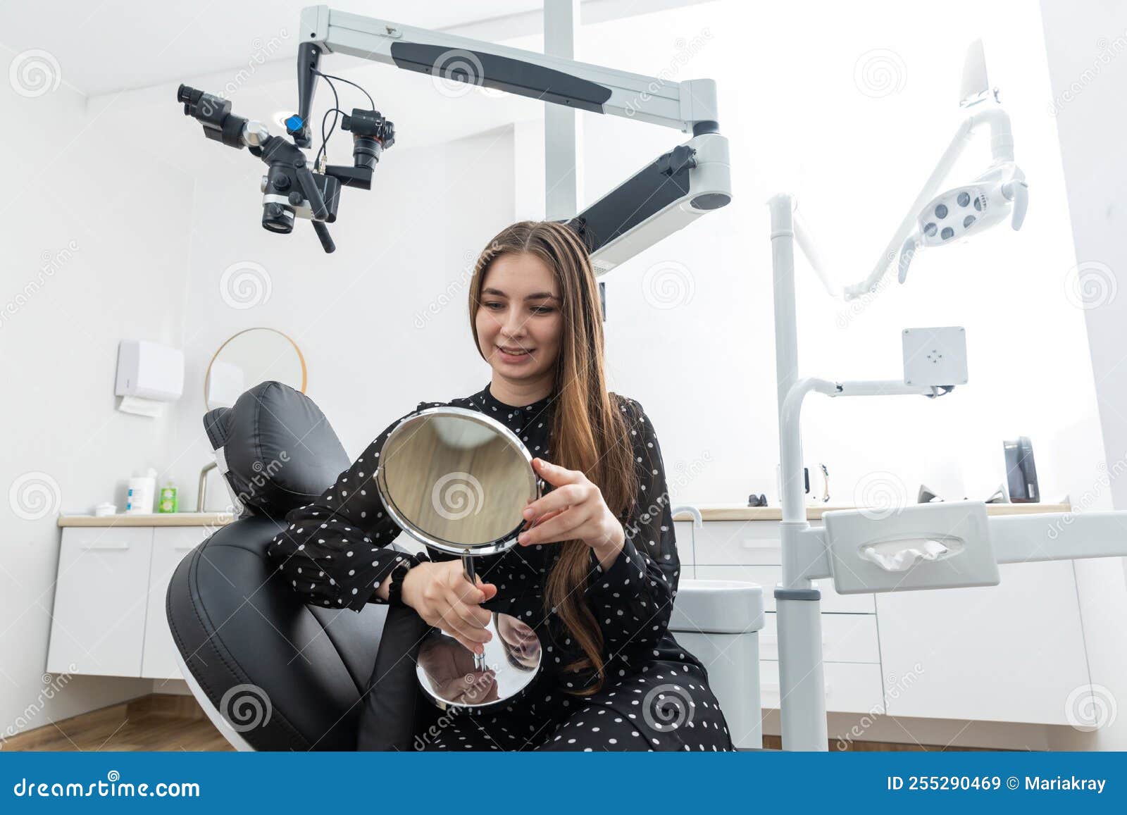 Young Woman Looking in the Mirror after a Dental Procedure Stock Image ...