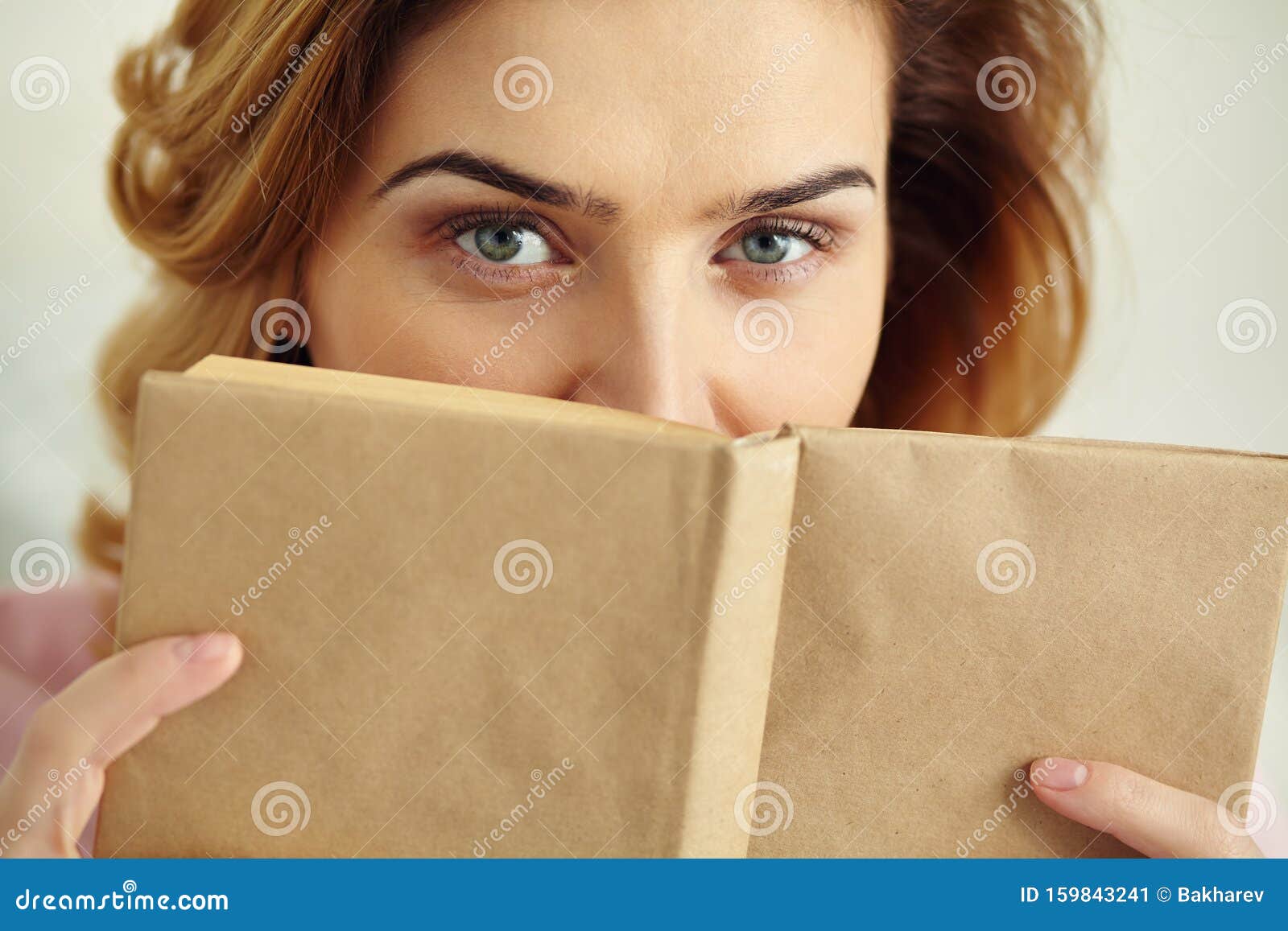 Young Woman Looking Over a Book. Reading and Eyes. Stock Image - Image ...
