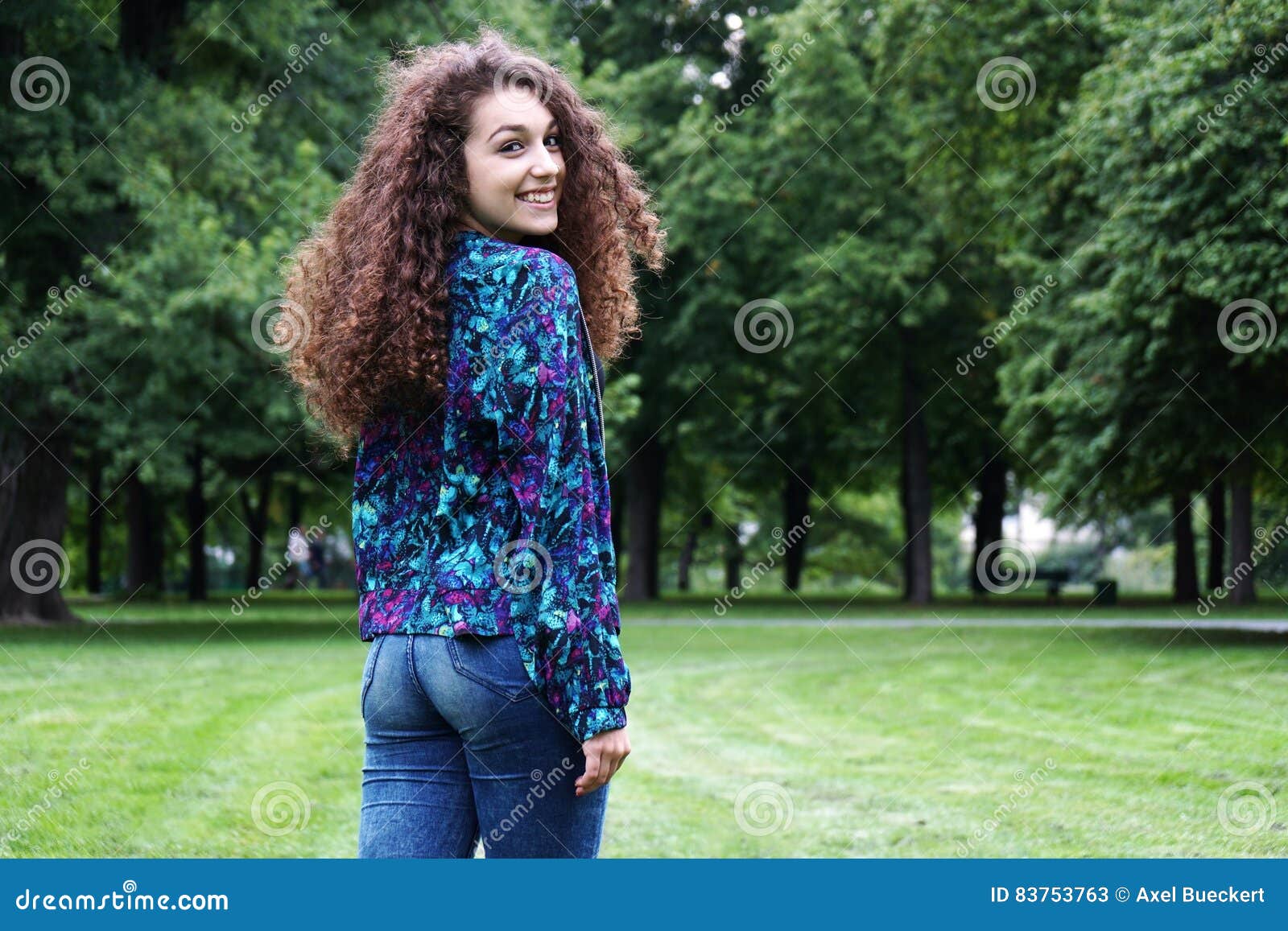 Young Woman Looking Over Her Shoulder Stock Image - Image of jeans ...