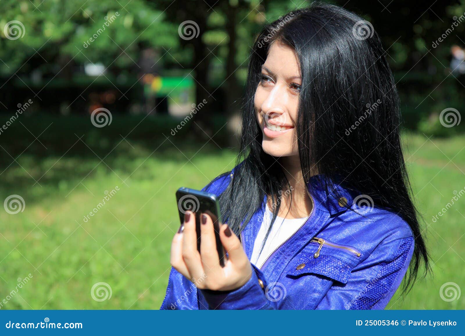 Young Woman Looking at Phone and Smiling Stock Photo - Image of ...