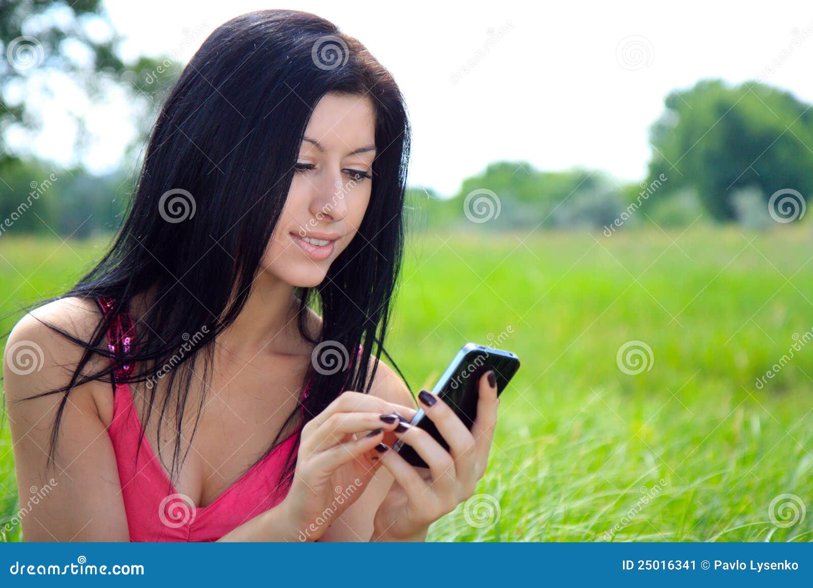 Young Woman Looking at Phone and Smiling Stock Image - Image of ...