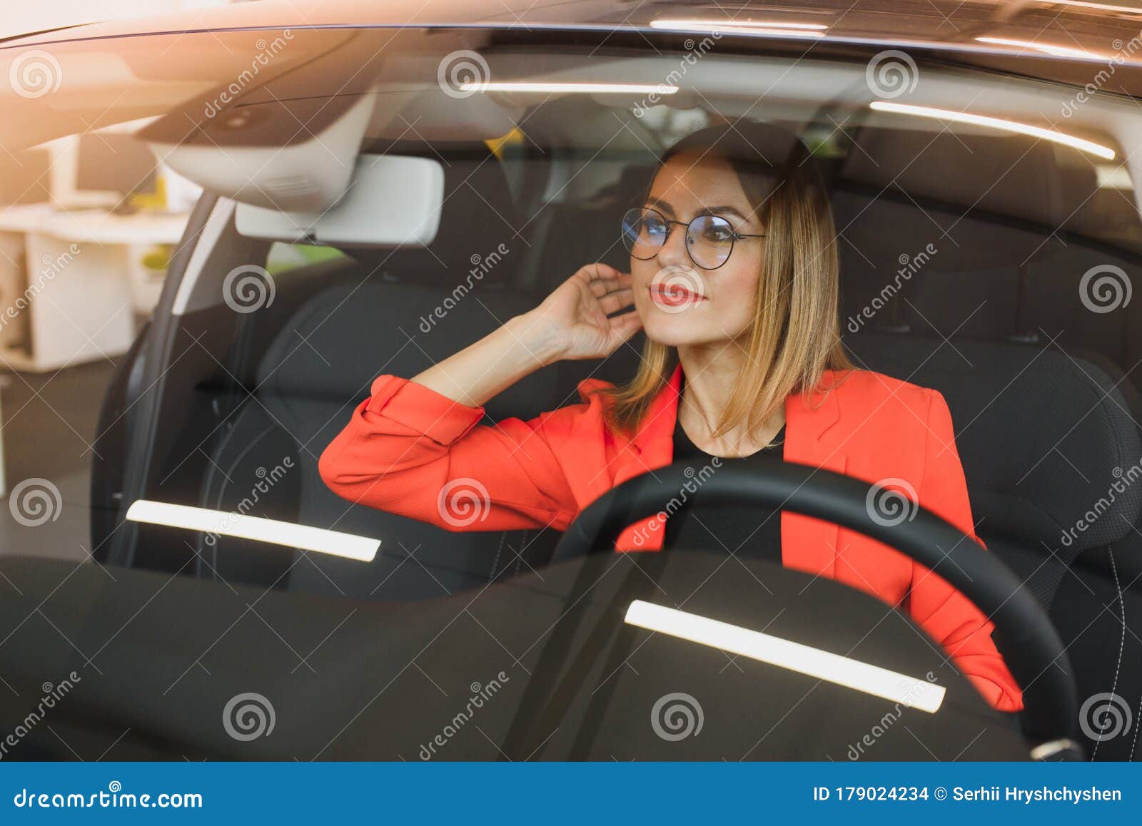 Young Woman Looking in the Rearview Mirror of a Car Stock Photo - Image ...