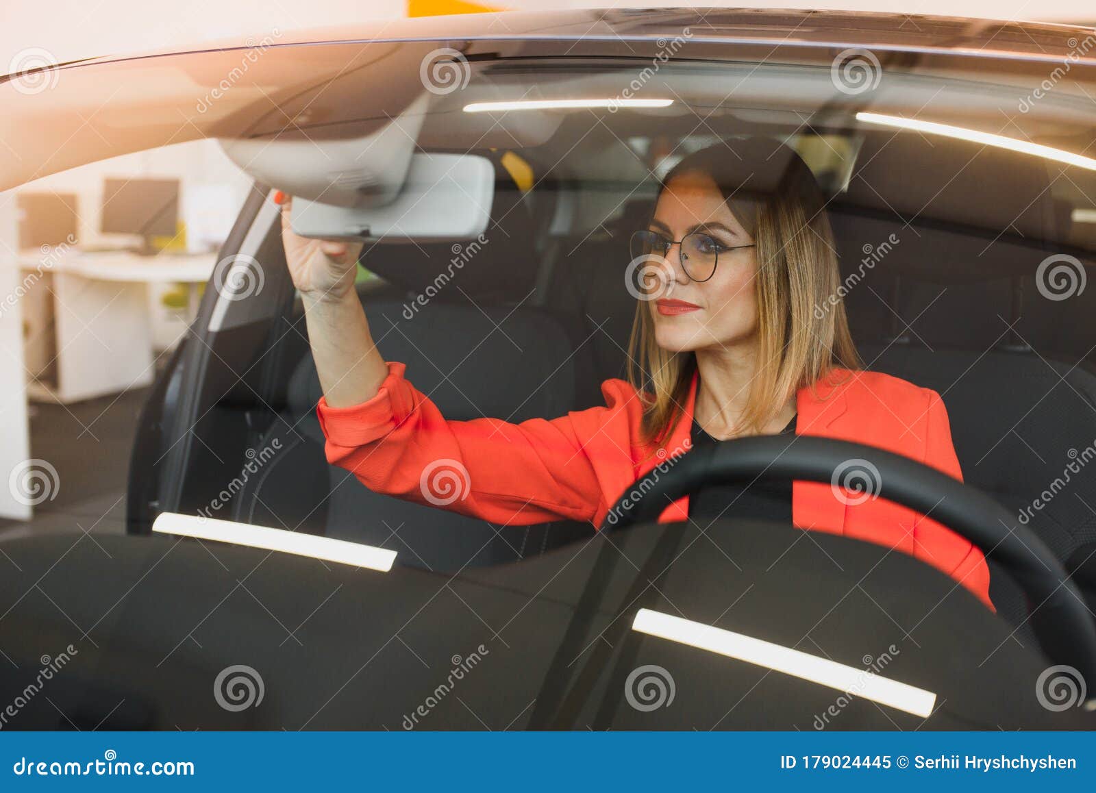 Young Woman Looking in the Rearview Mirror of a Car Stock Image - Image ...