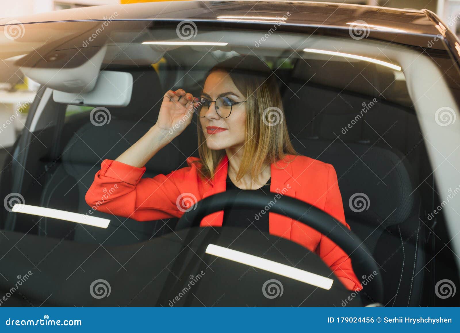 Young Woman Looking in the Rearview Mirror of a Car Stock Photo - Image ...