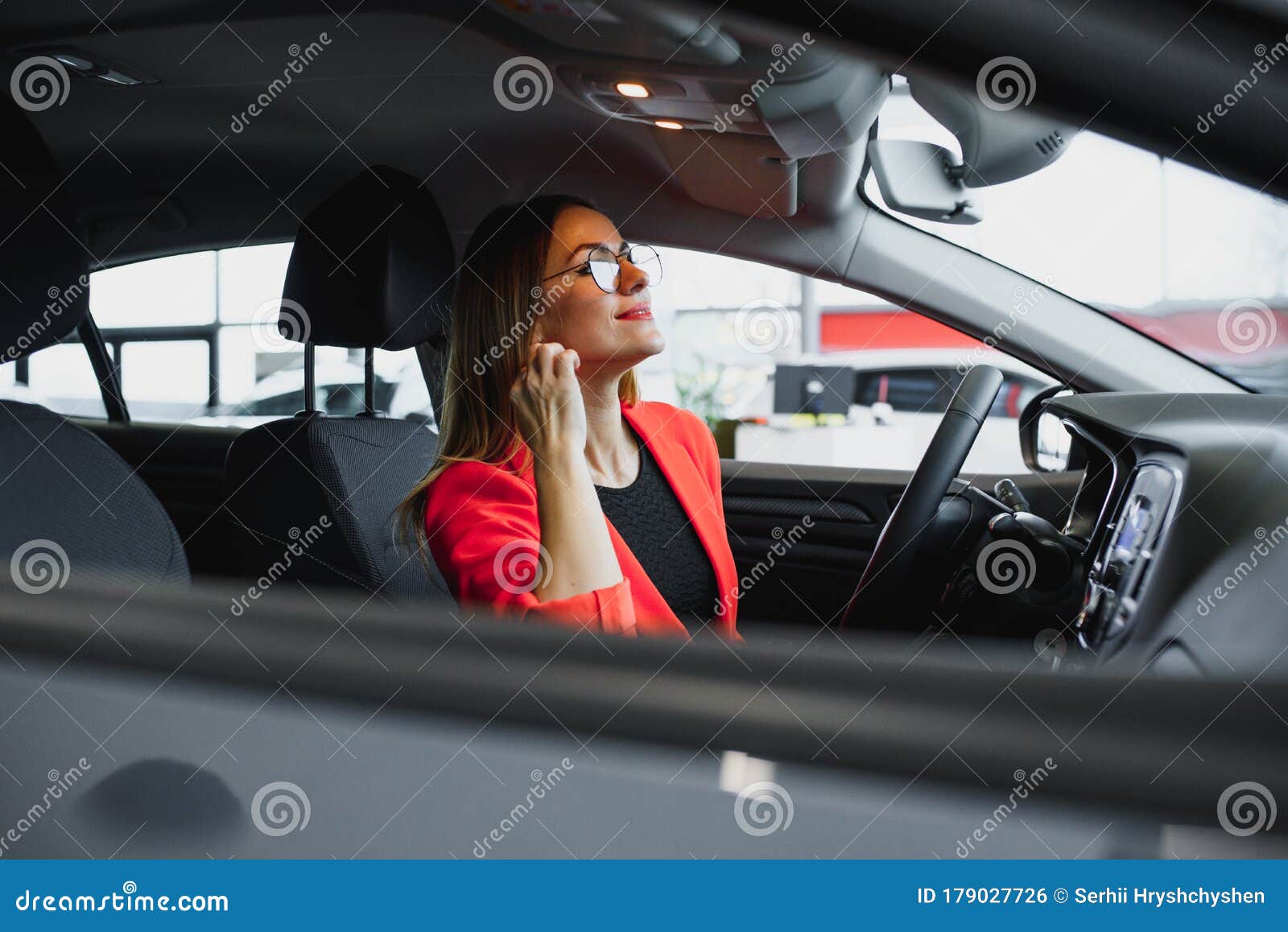 Young Woman Looking in the Rearview Mirror of a Car Stock Photo - Image ...