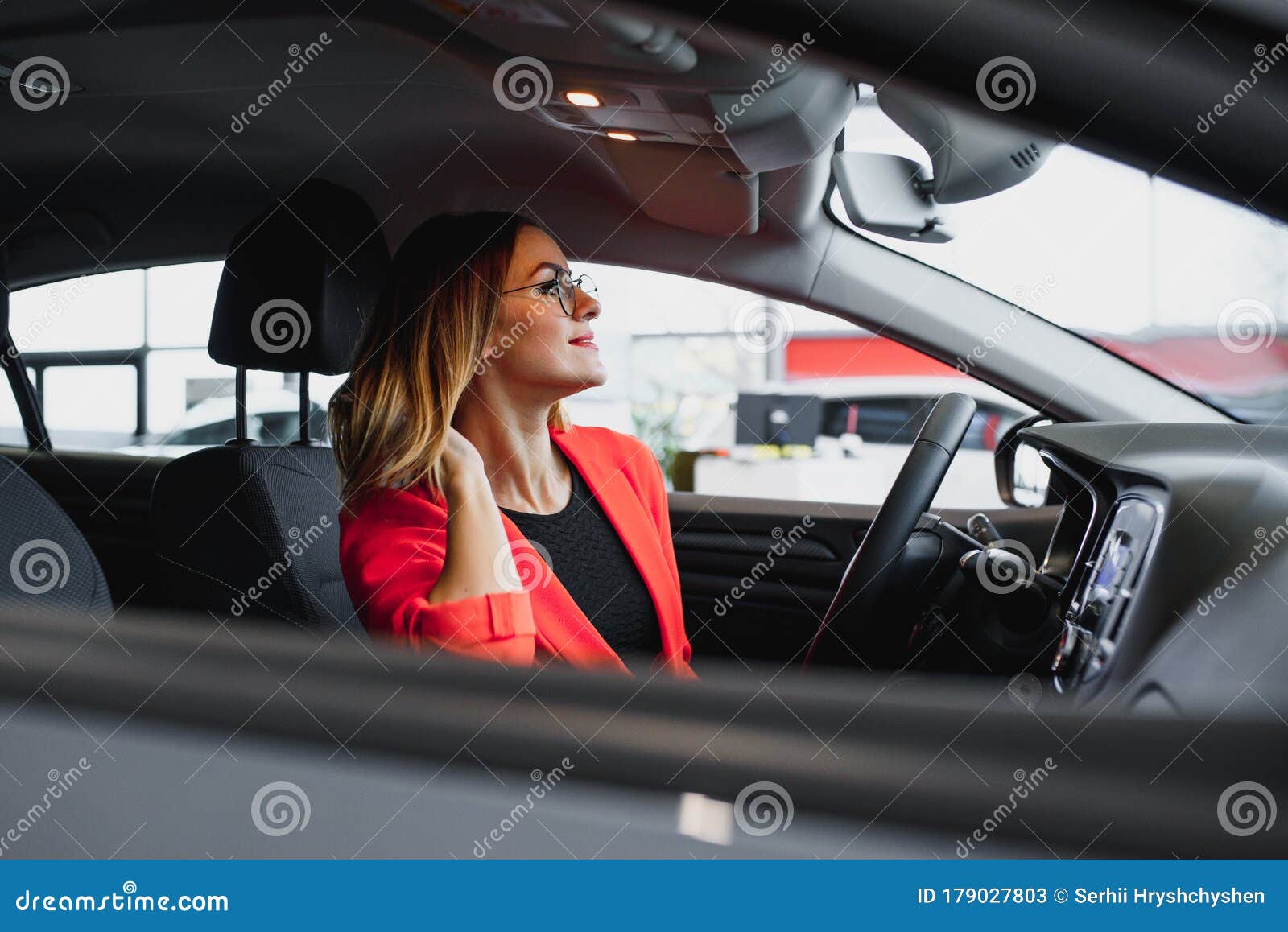 Young Woman Looking in the Rearview Mirror of a Car Stock Image - Image ...