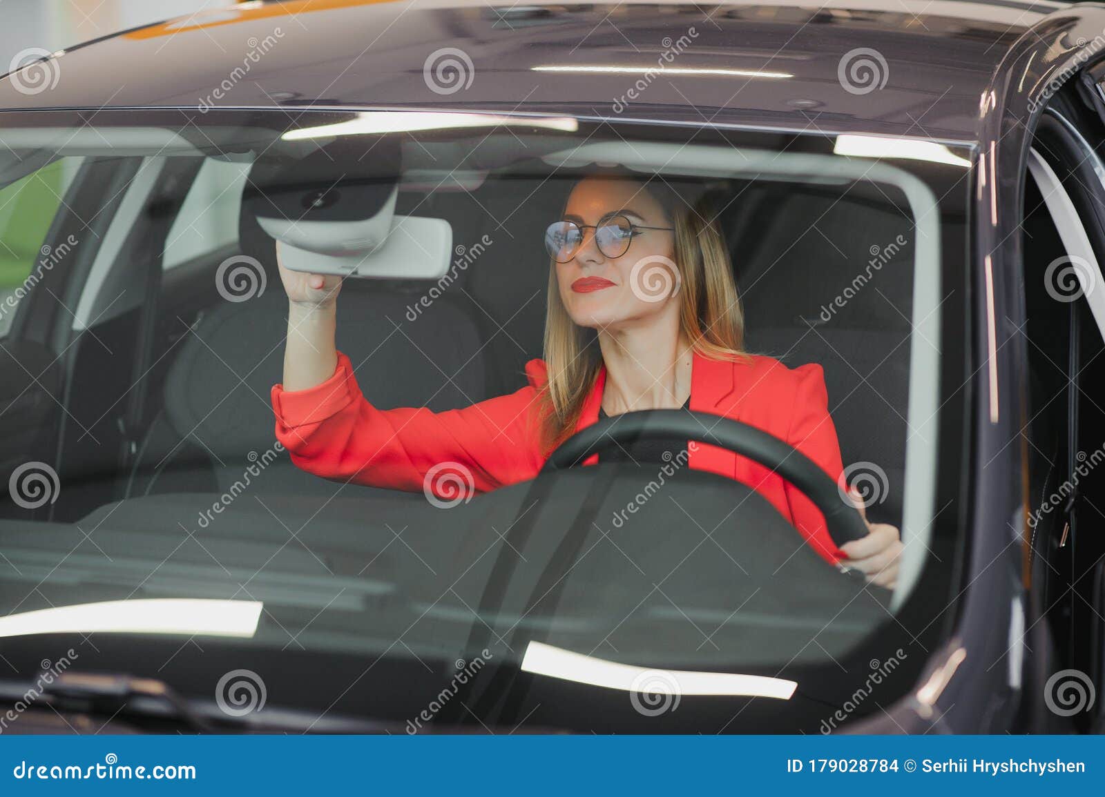 Young Woman Looking in the Rearview Mirror of a Car Stock Photo - Image ...