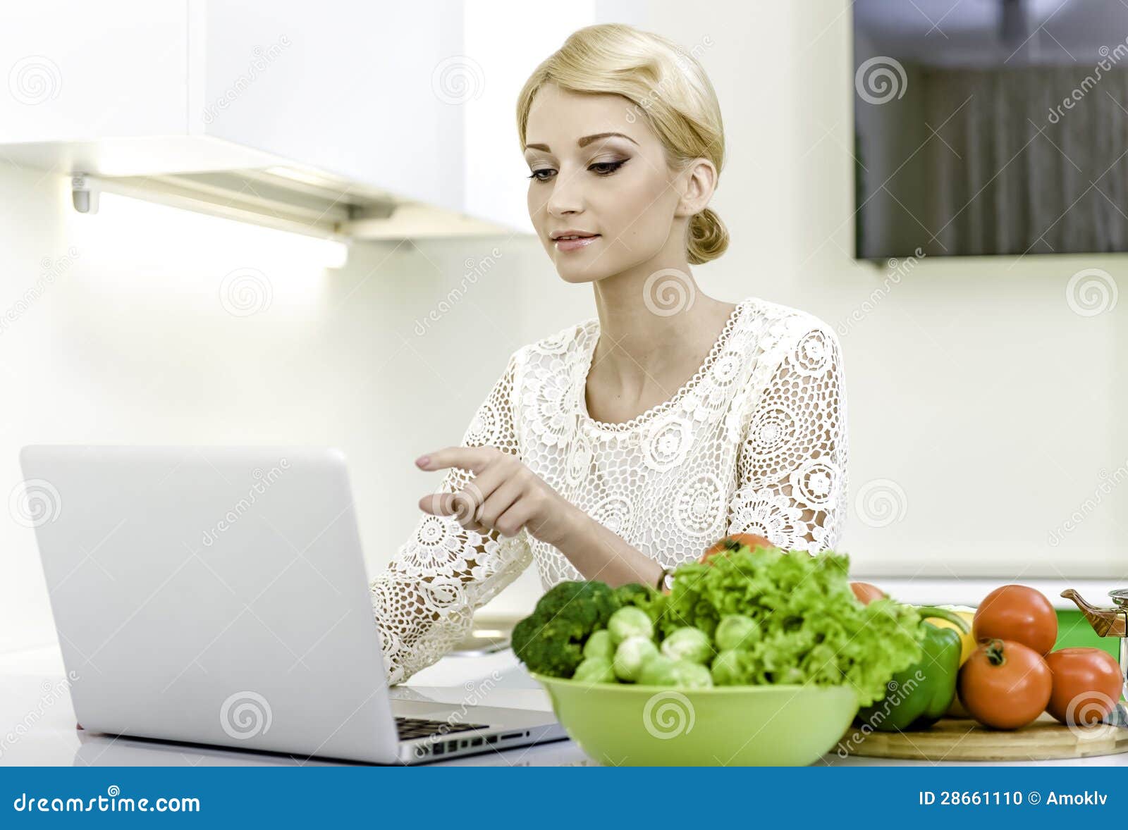 Young Woman Looking for a Recipe on the Laptop Computer in the Kitchen ...