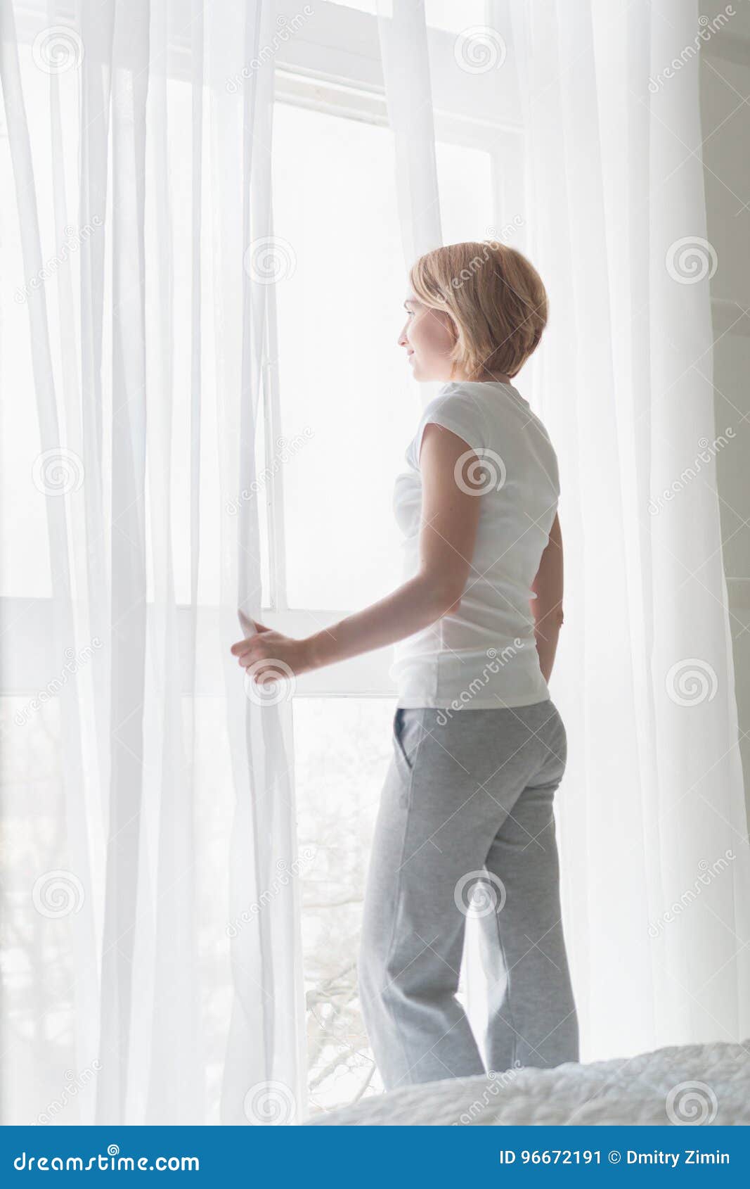 Young Woman Looking at Window in the Morning Stock Image - Image of ...
