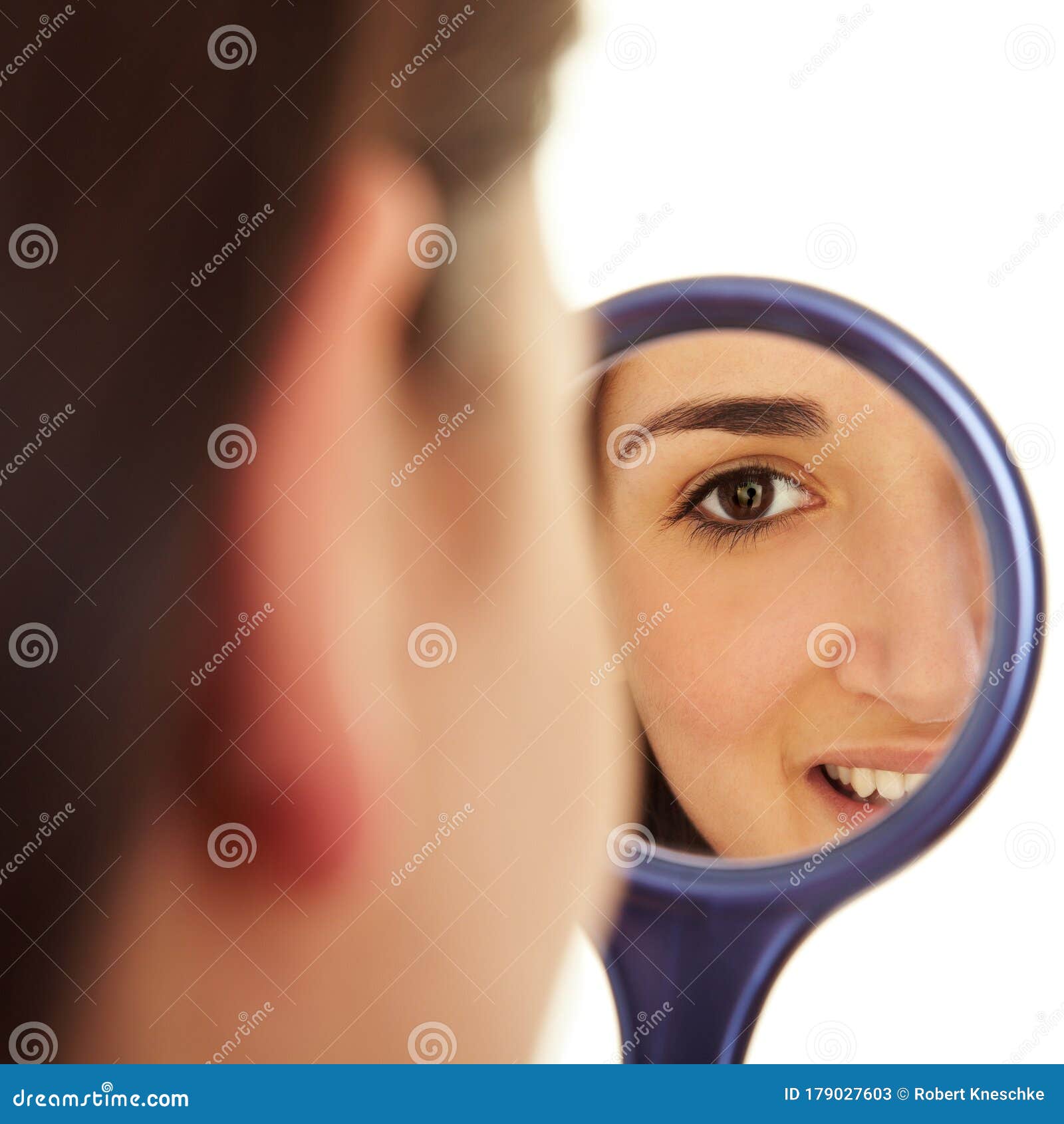 Young Woman Looks in Mirror Stock Image - Image of vanity, vain: 179027603