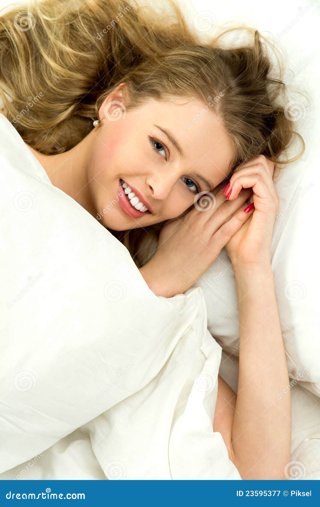 Young woman lying in bed stock image. Image of beautiful - 23595377