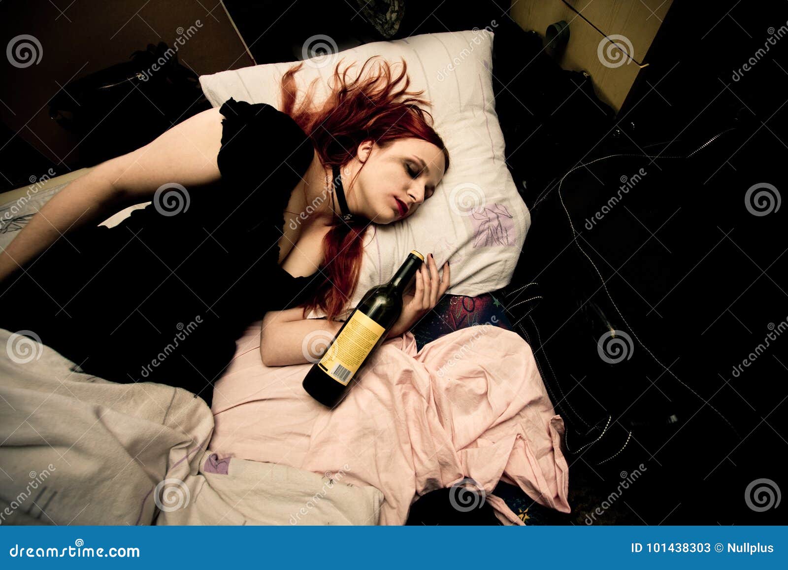 Young Woman Lying in Bed with Bottle of Wine Stock Image - Image of ...
