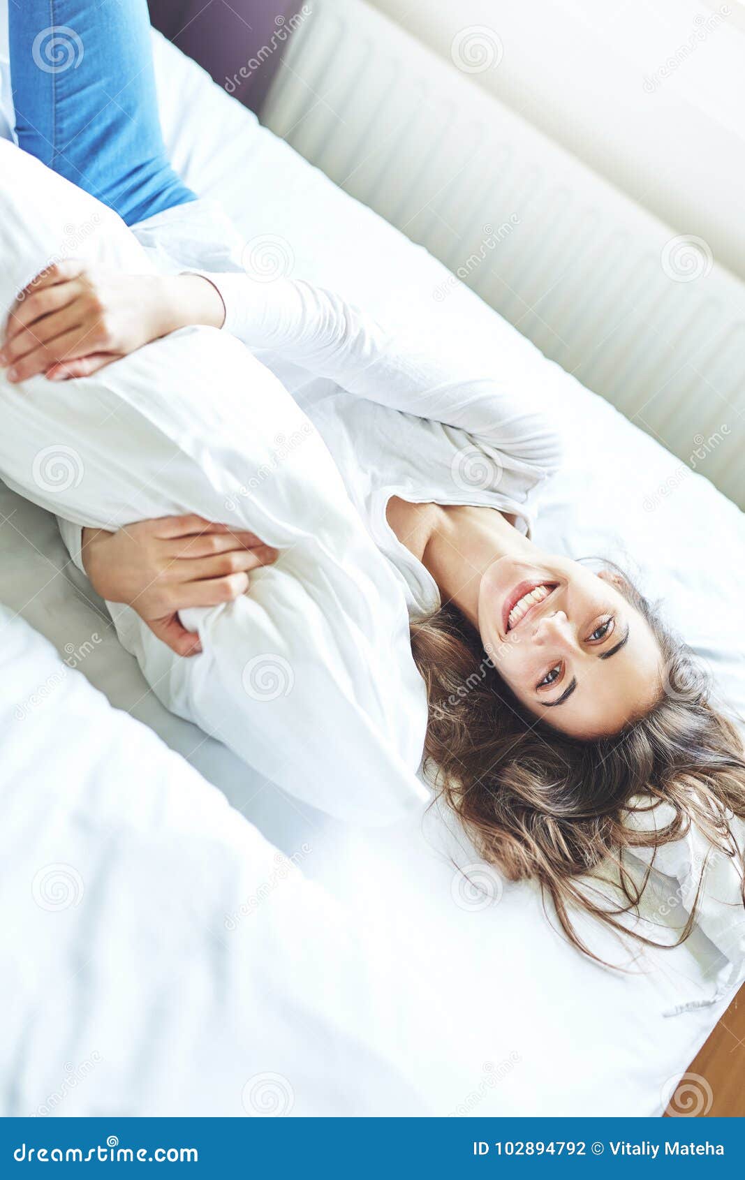 Young Woman Lying on Bed Hugging Pillow Stock Photo - Image of life ...