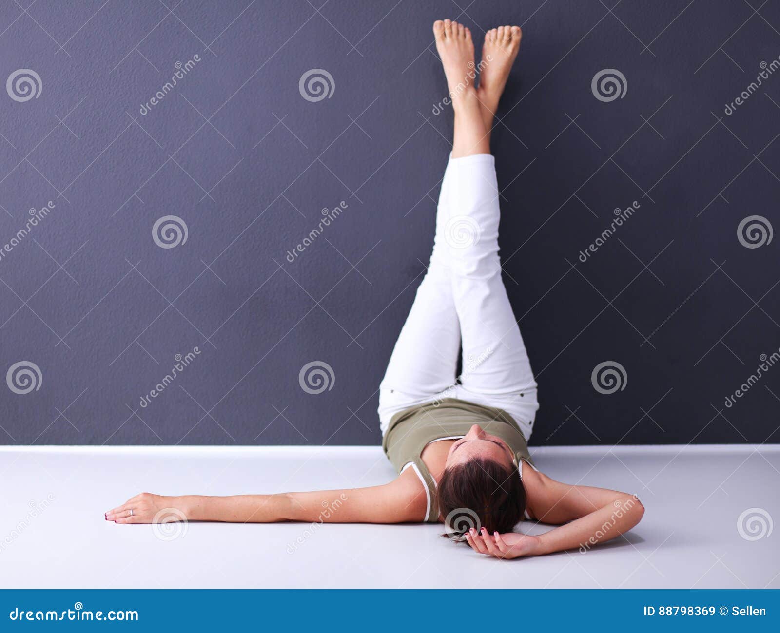 Young Woman Lying on the Floor with Legs Up Stock Image - Image of ...