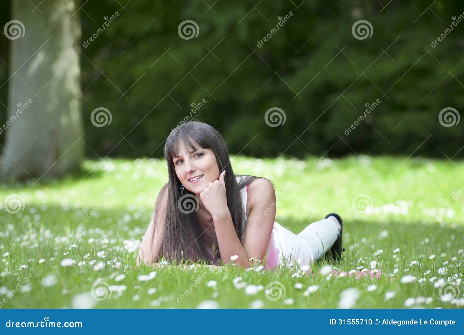 Young Woman Lying in a Grass Field Wth Daisies Stock Photo - Image of ...