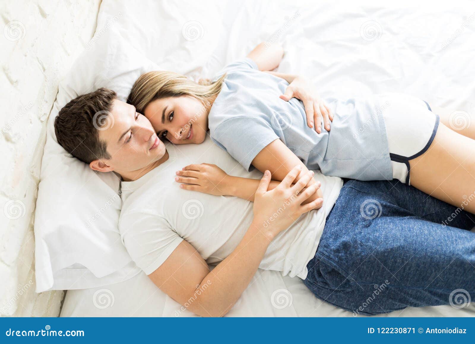 Young Woman Lying On Man In Bed At Home Stock Image Image Of