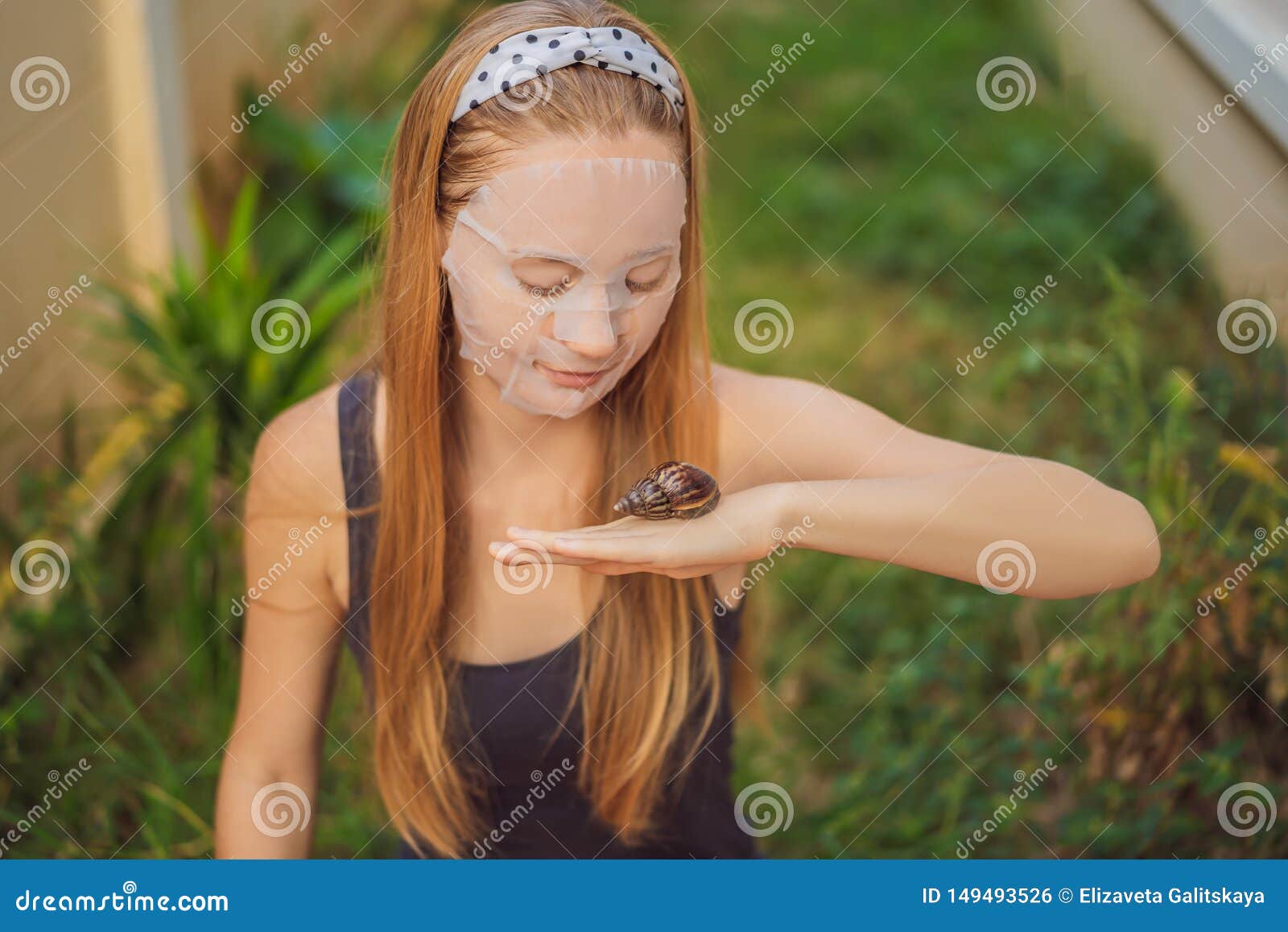 A Young Woman Makes a Face Mask with Snail Mucus. Snail Crawling on a ...
