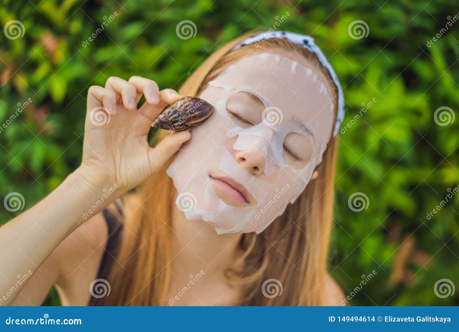 A Young Woman Makes a Face Mask with Snail Mucus. Snail Crawling on a ...