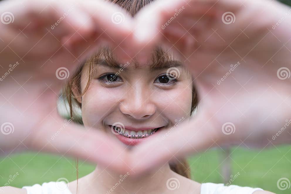 Young Woman Making A Heart Gesture With Her Fingers Asian Girl Stock