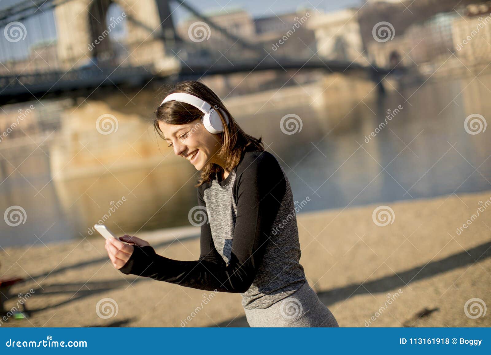 Woman Making a Pause after the Exercise and Using Mobile Phone Stock ...