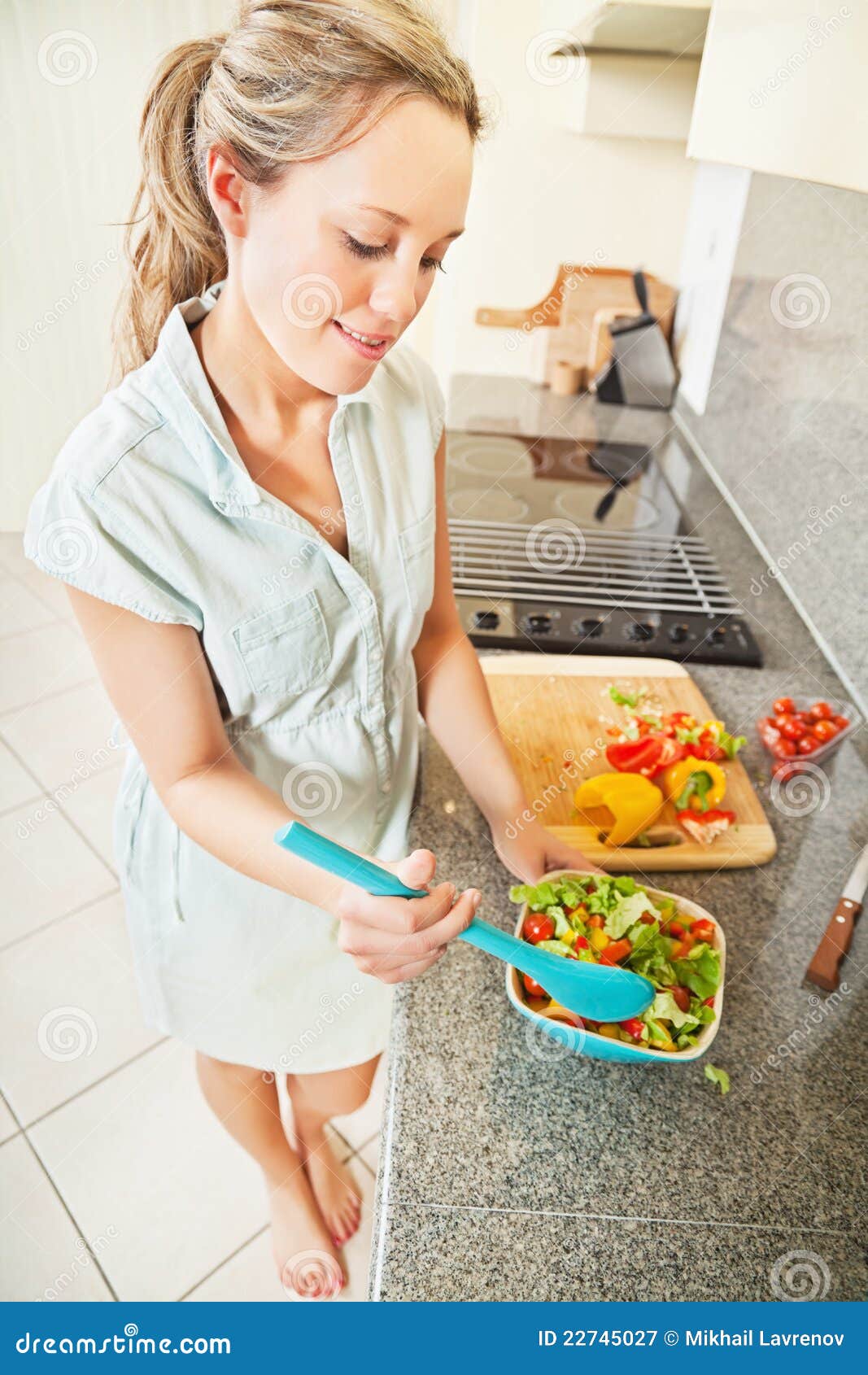 Young woman making salad stock image. Image of casual - 22745027