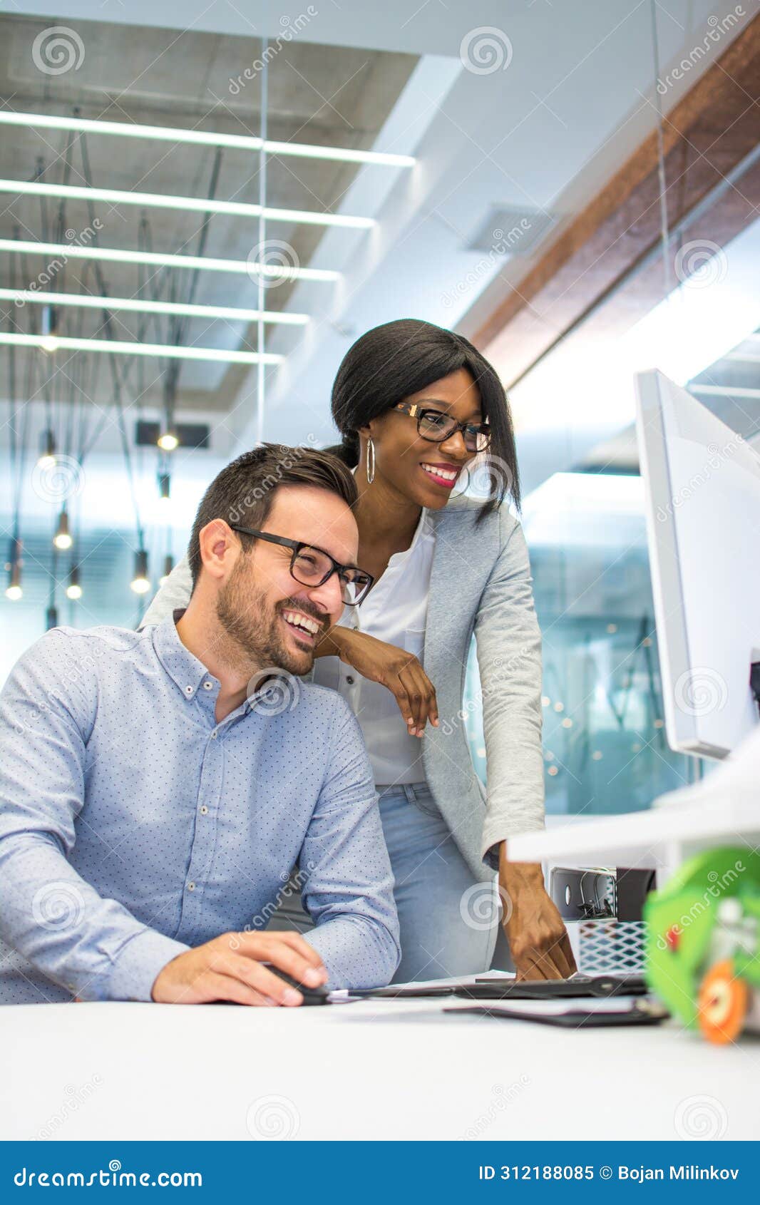 Young Woman and Man Working Together on Desktop Pc in the Modern Office ...