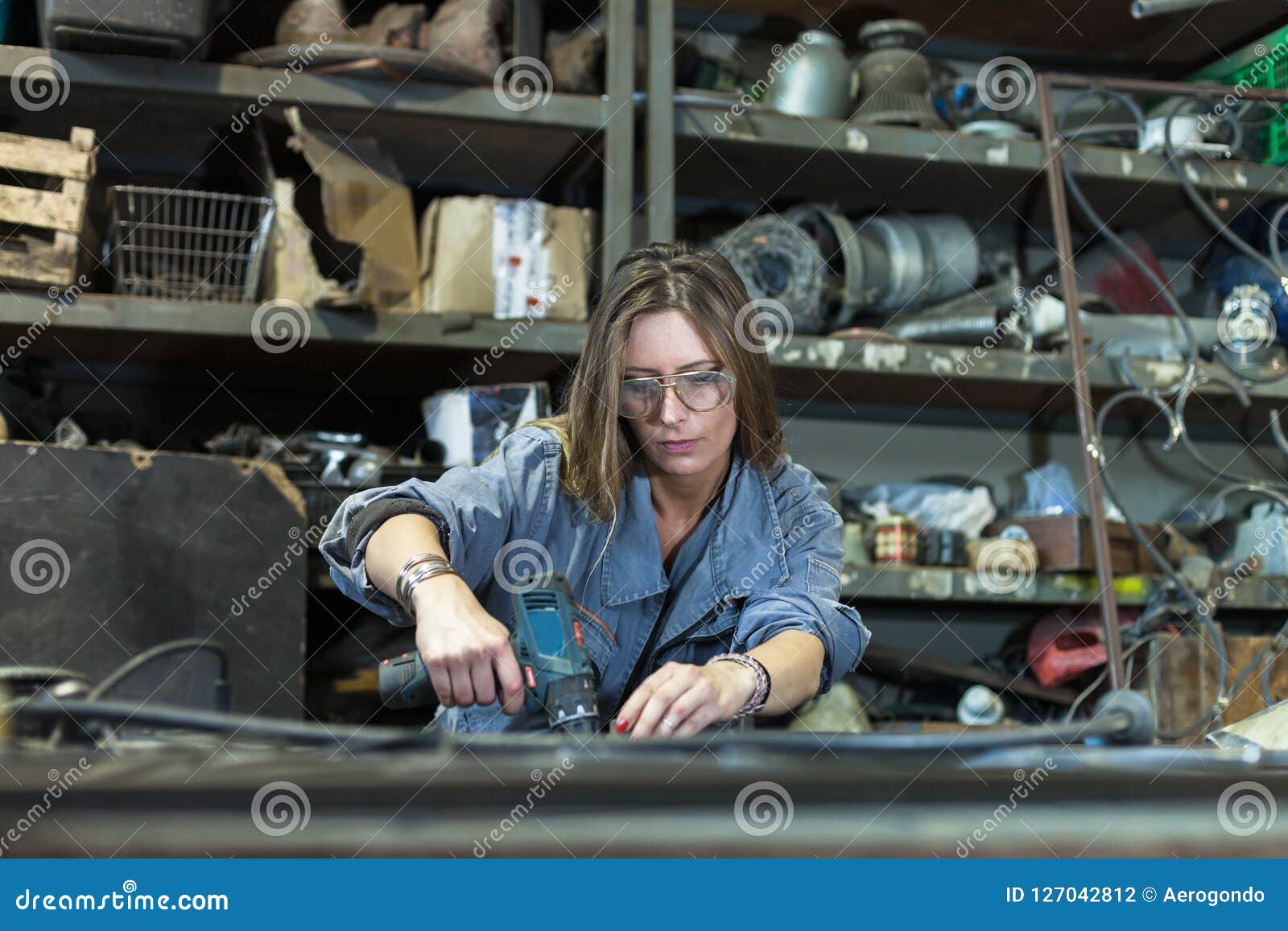 Young Woman Mechanic in a Workshop Stock Photo - Image of indoors ...