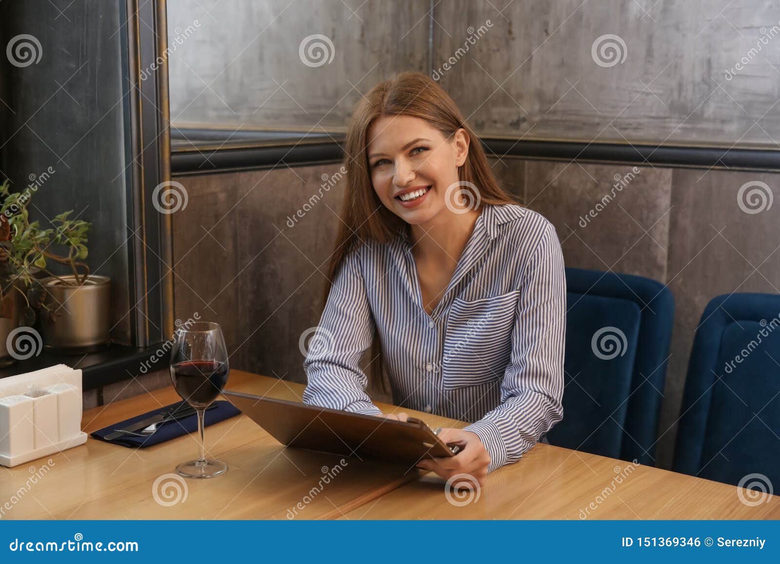 Young Woman with Menu Sitting in Restaurant Stock Photo - Image of ...