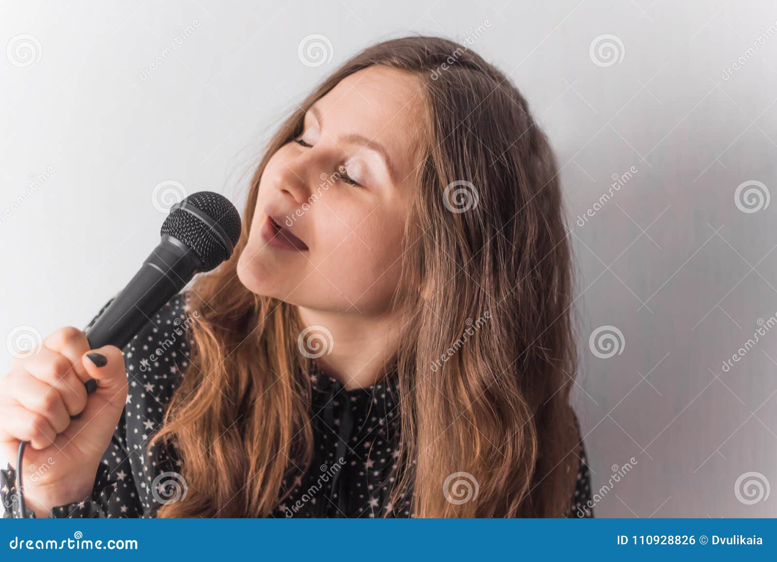 Young Woman with a Microphone in Hands Stock Photo - Image of ...