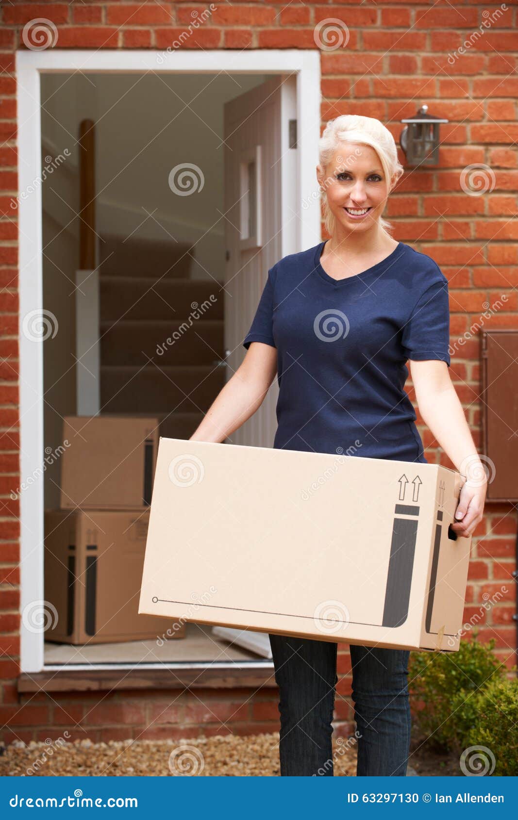 Young Woman Moving into New Home Stock Photo - Image of smiling ...