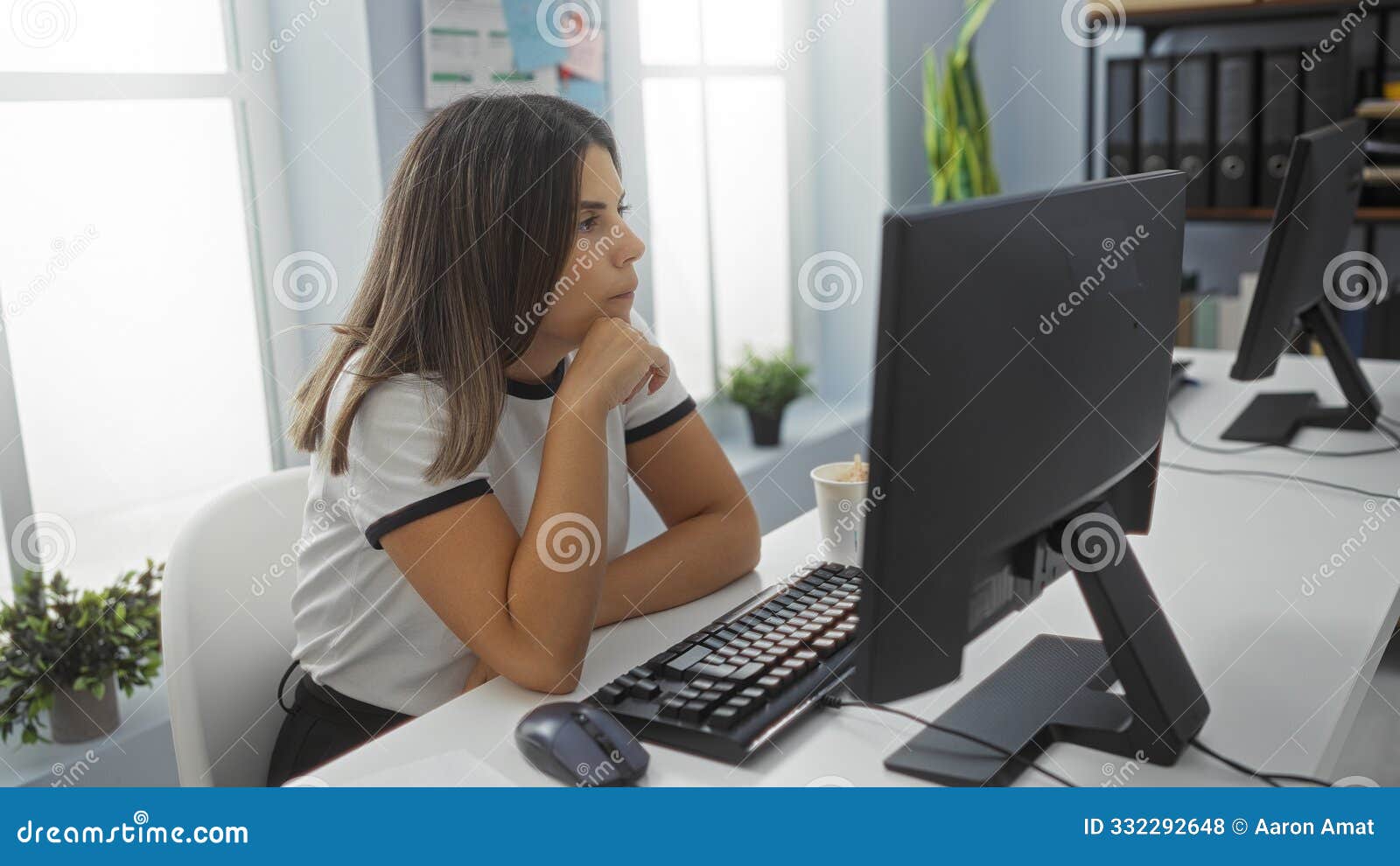 Young Woman in Office Working on Computer in a Modern Workplace Setting ...